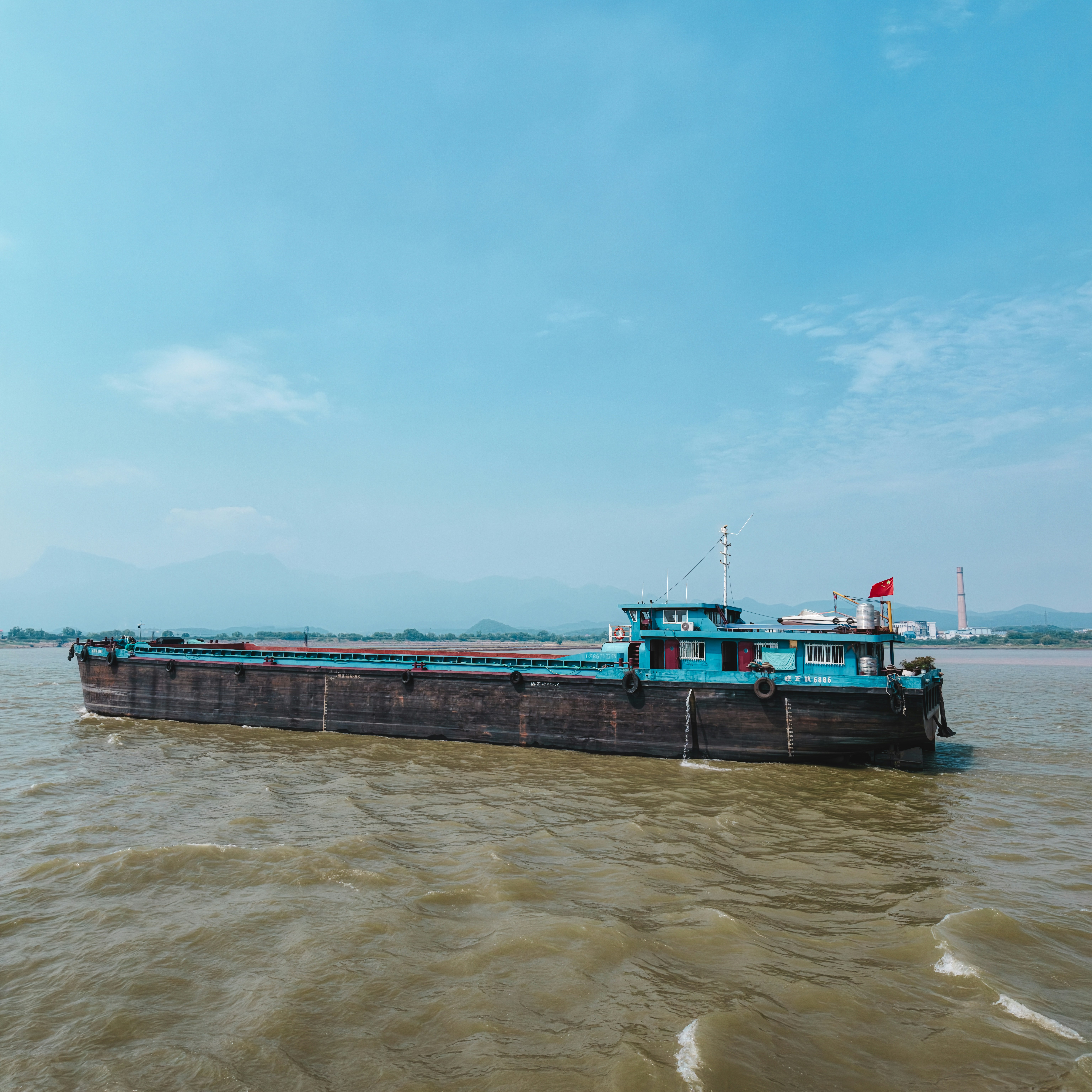 Blue Tugboat on Muddy Inland Waters