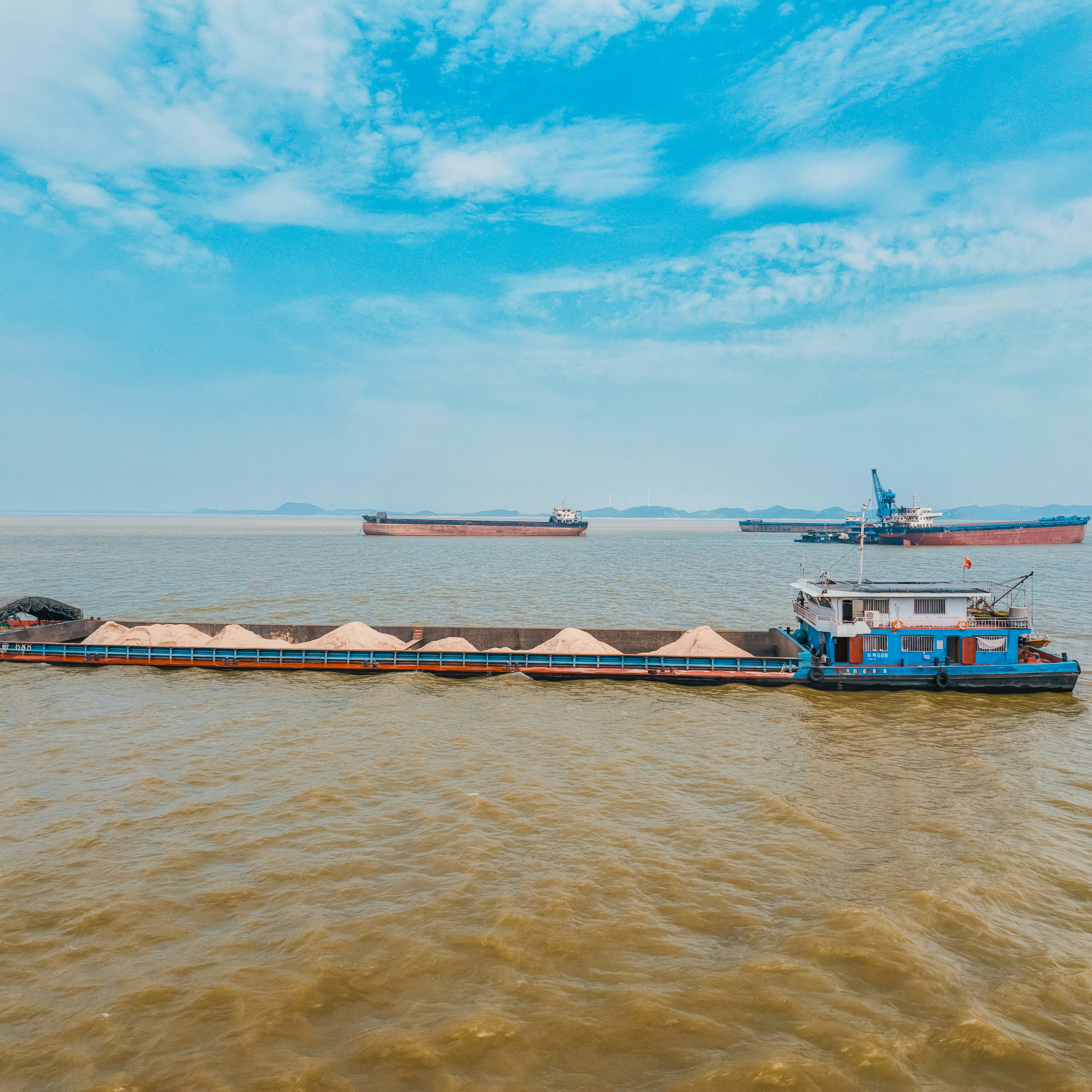 Blue Tugboat Stationed at a Coastal Barge Corridor