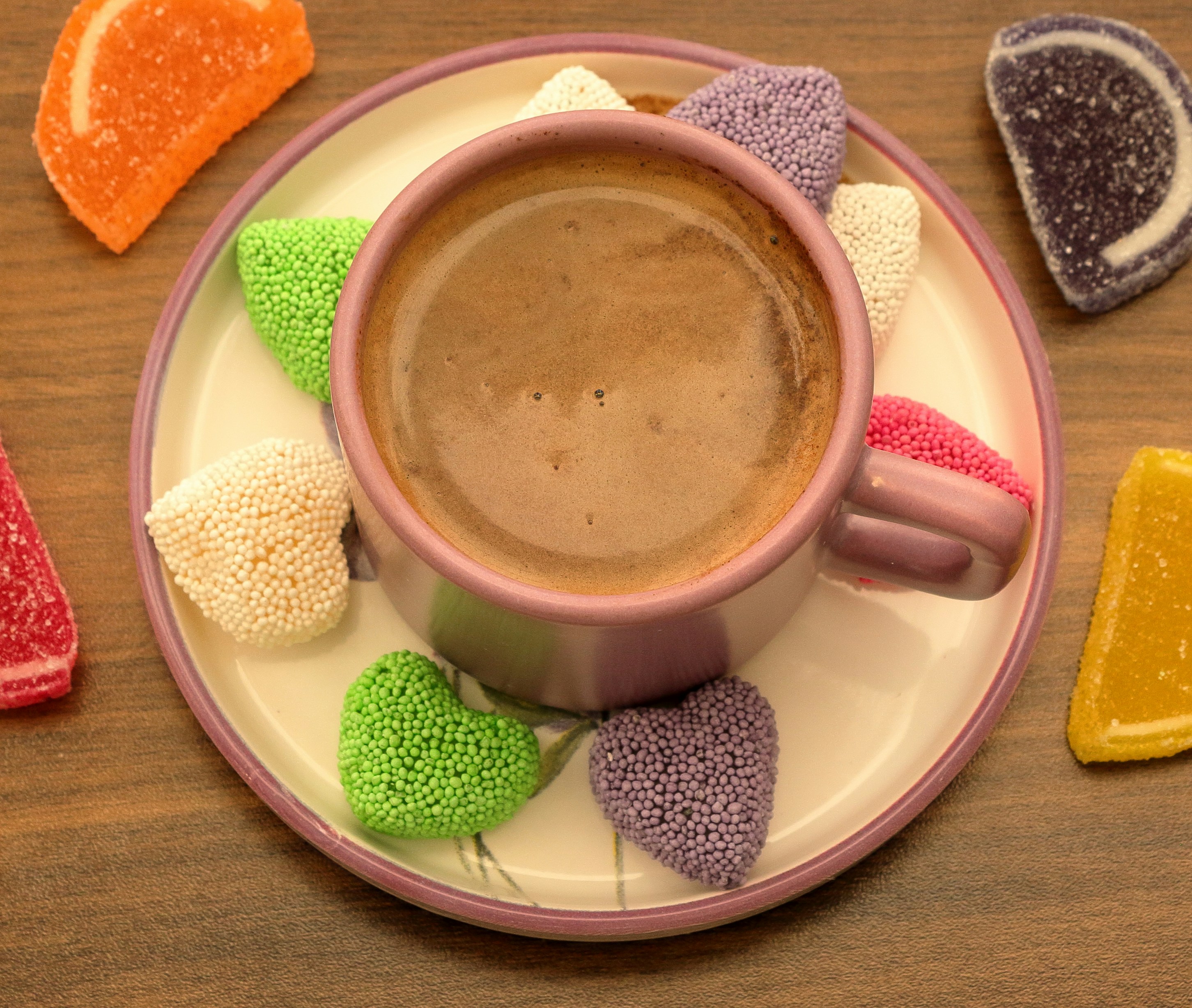 Sweet Interlude: A Cup of Warmth among Colorful Confections