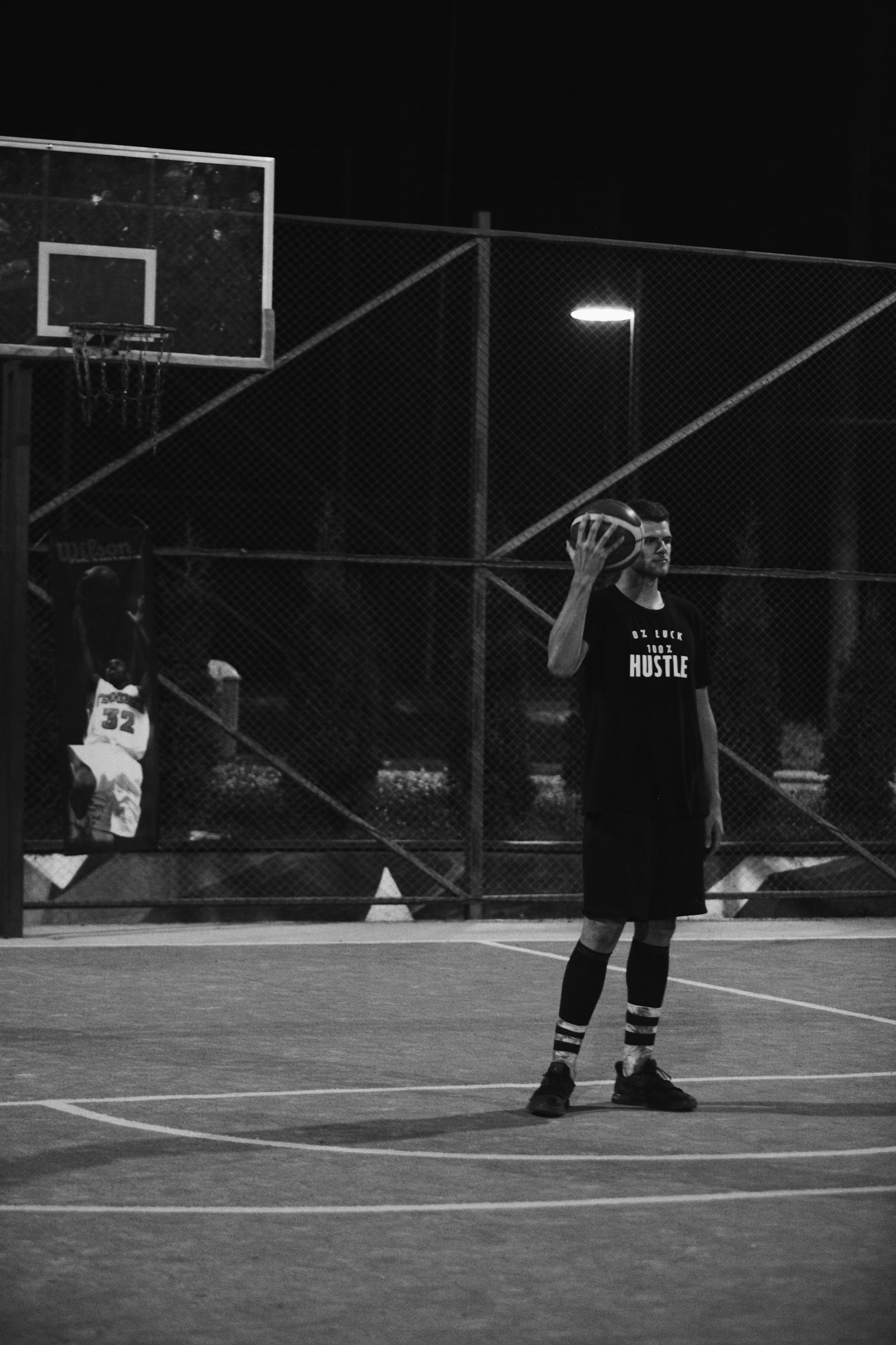 Courtside Quiet: A Lone Player Holds Court Under Night Lights