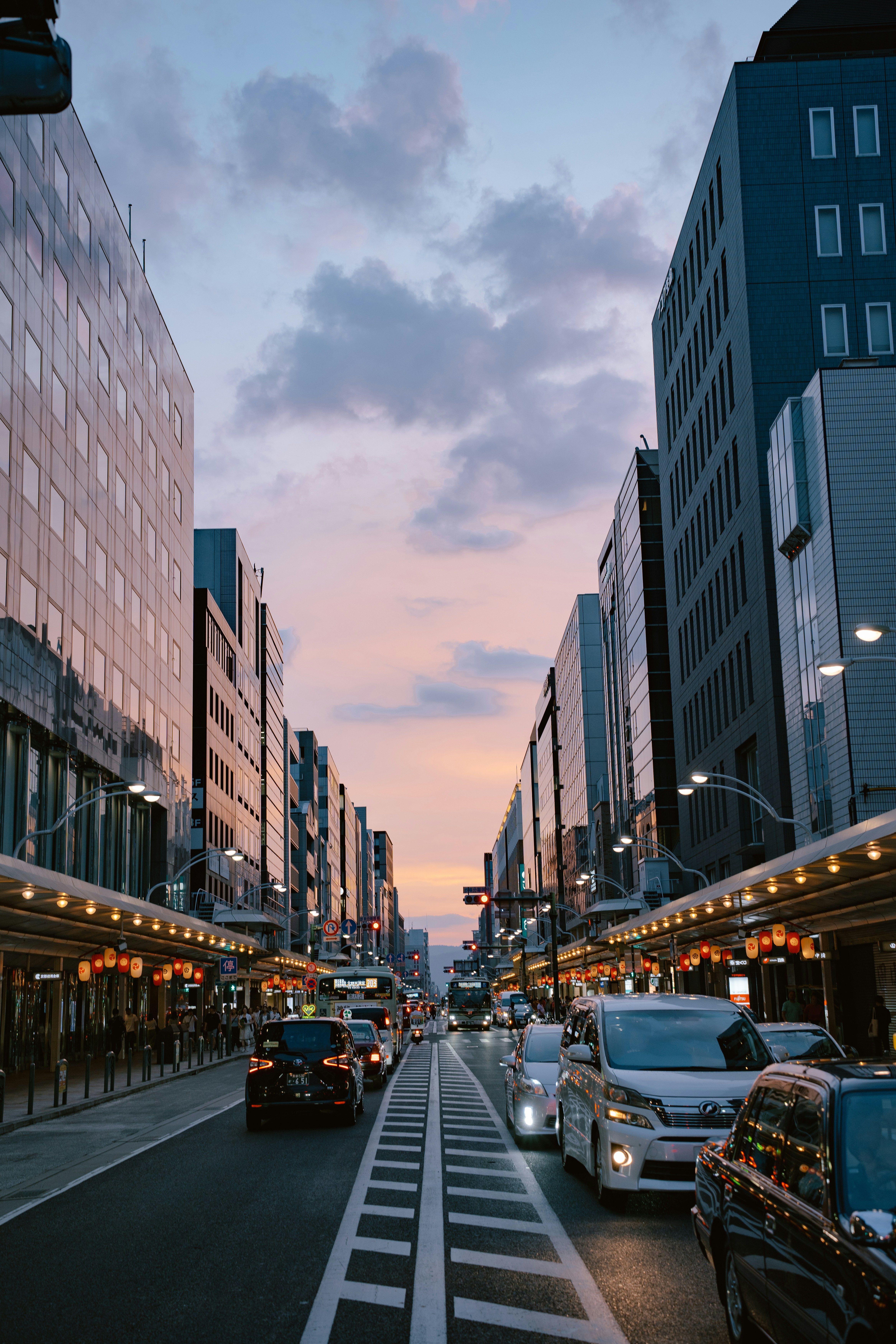Sunset Corridor: City Street Framed by Glass-and-Steel Skyscrapers