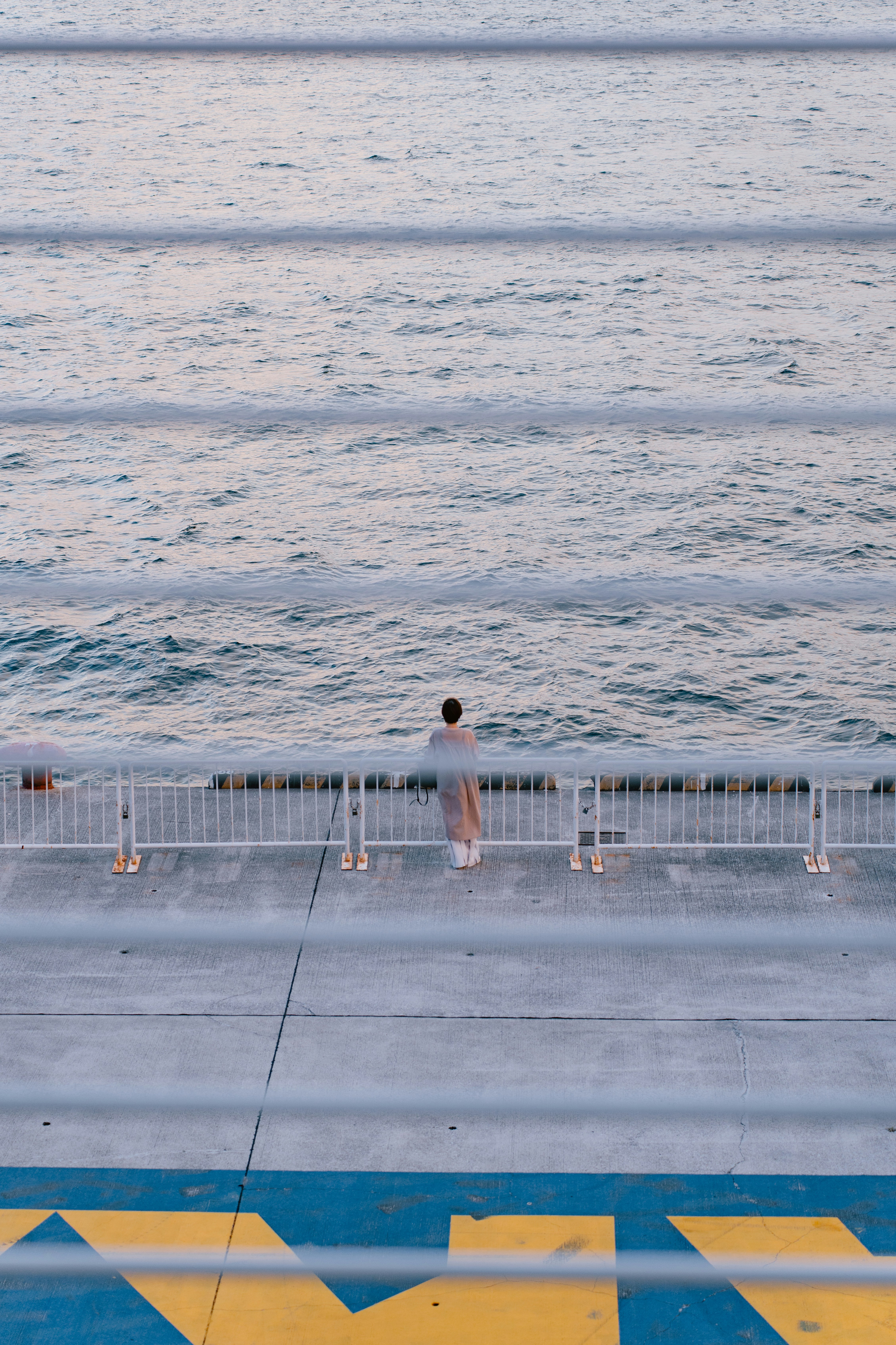 Figure by the Sea: A Quiet Moment on the Pier
