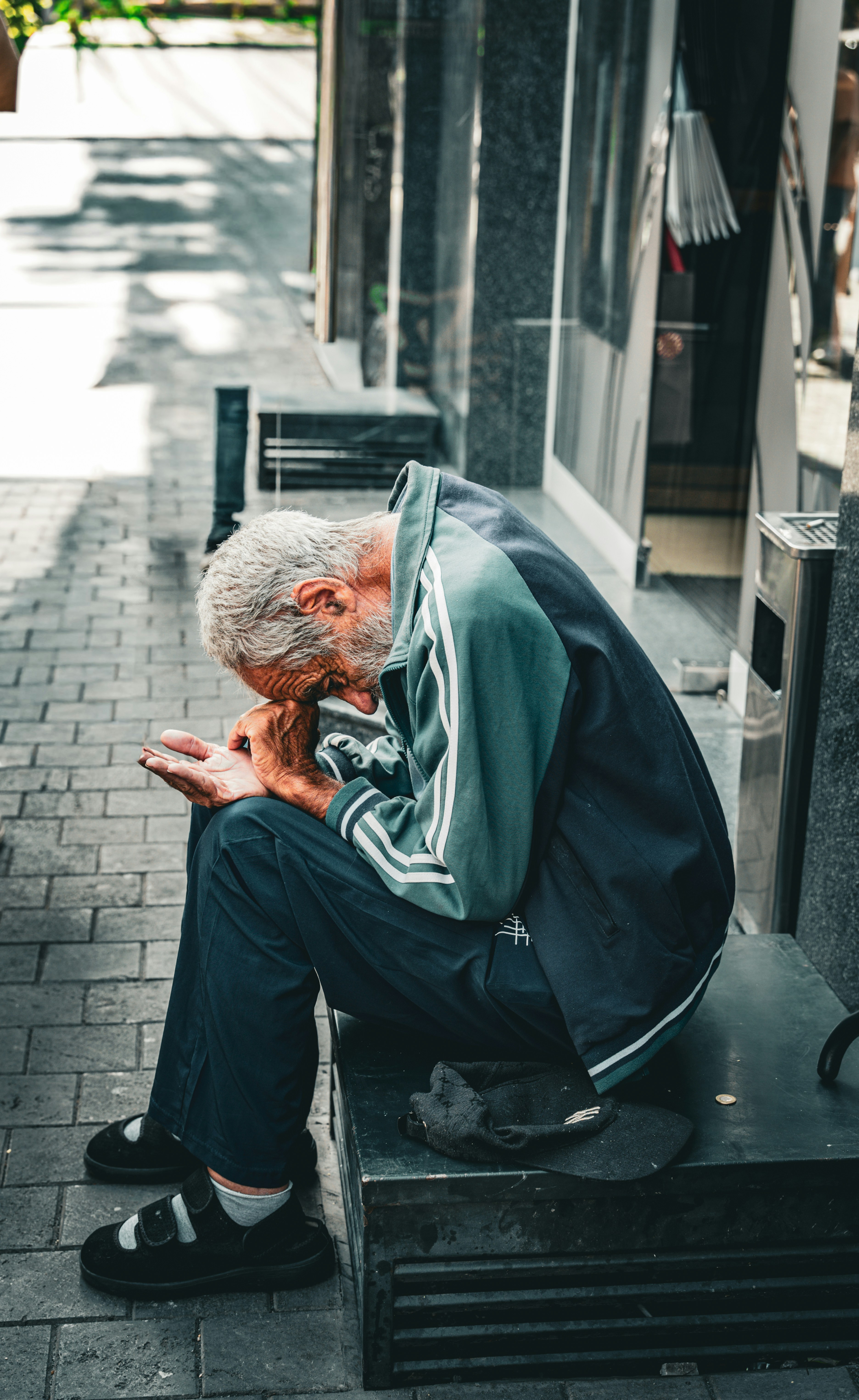 Weathered Hands, Quiet Resolve: A Street Saint in Shadowed Light