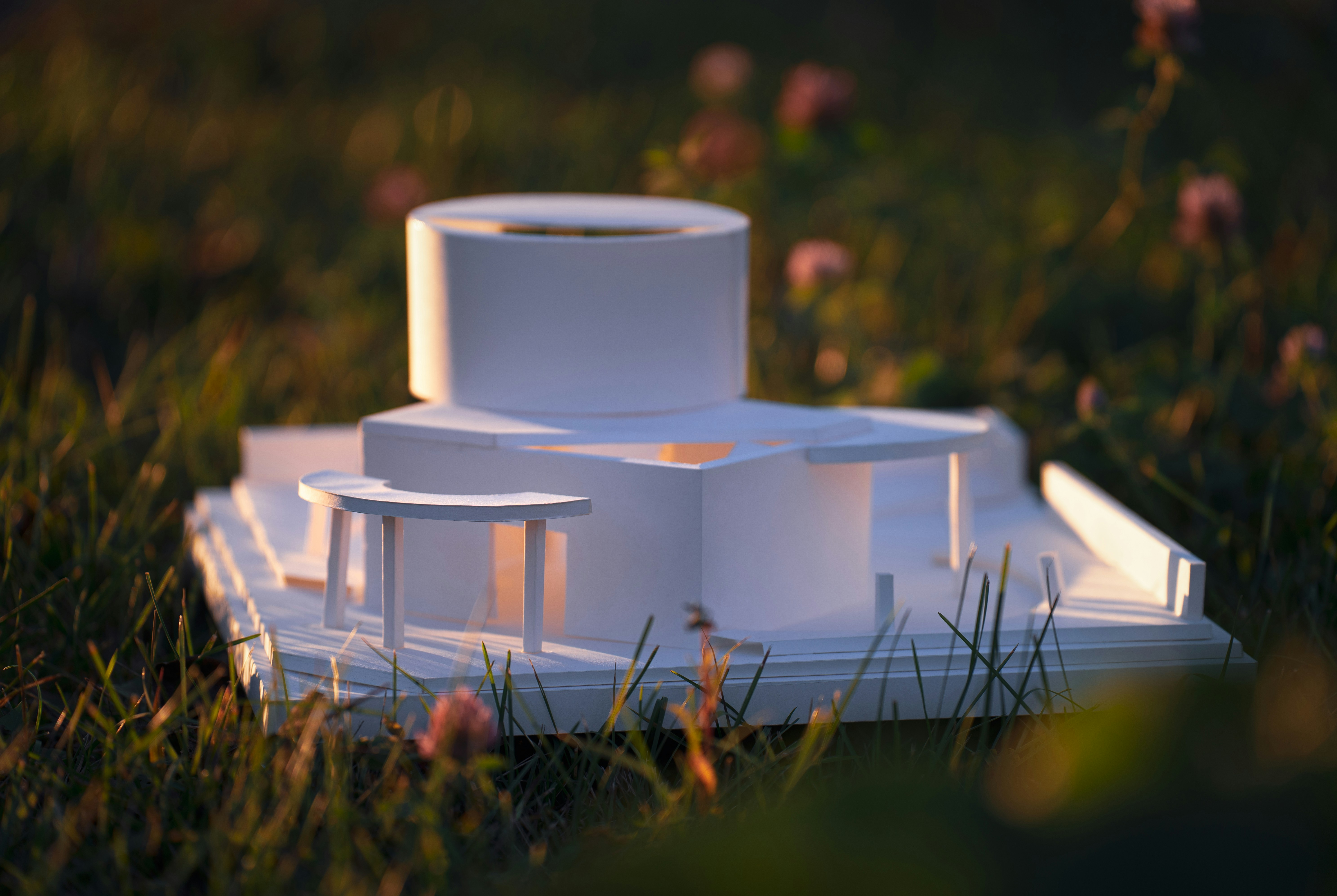 Minimalist White Pavilion Model Bathed inGolden Hour Glow