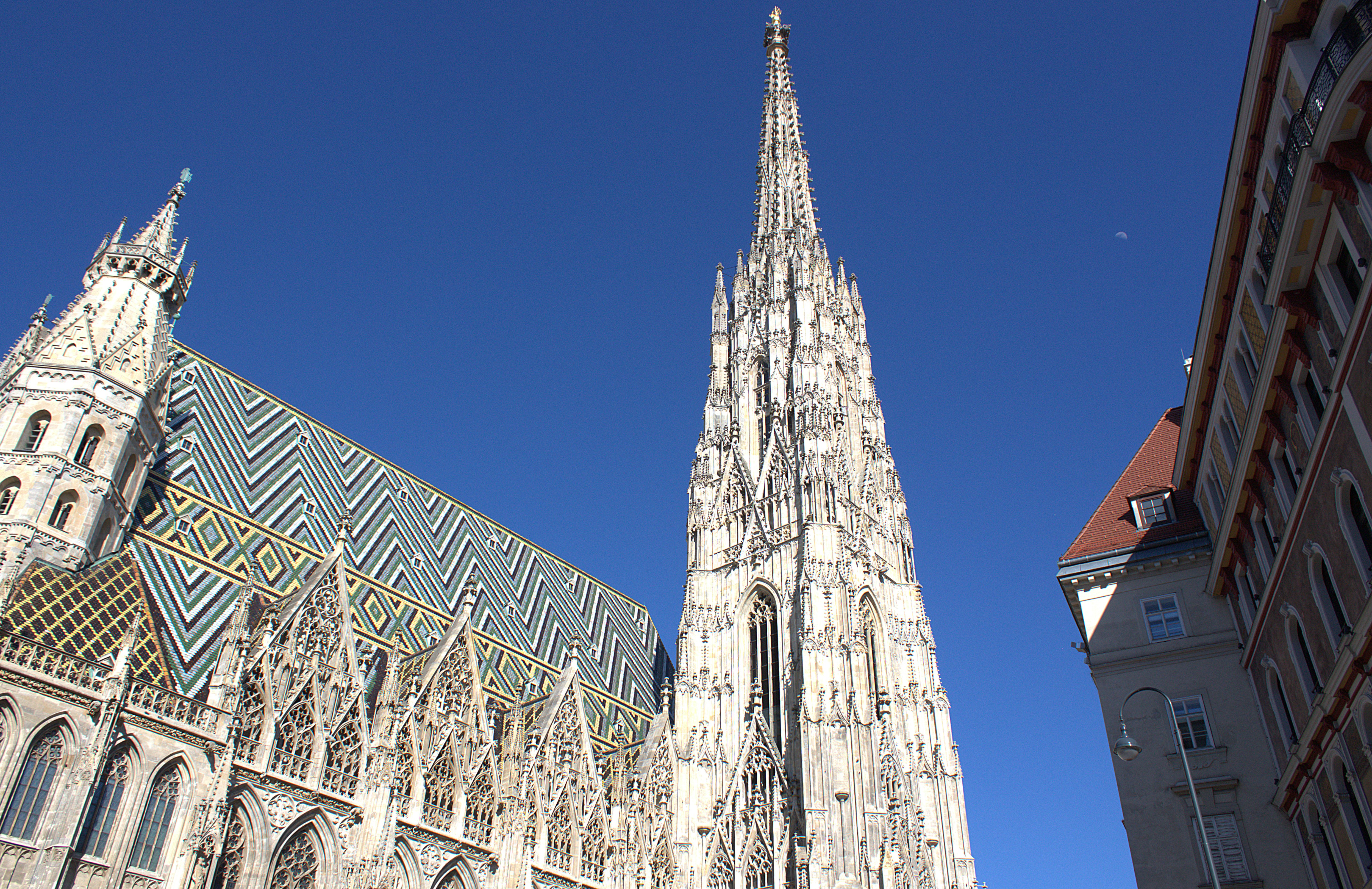 Gothic Spire Rising Above a Facade of Tiles and Brick