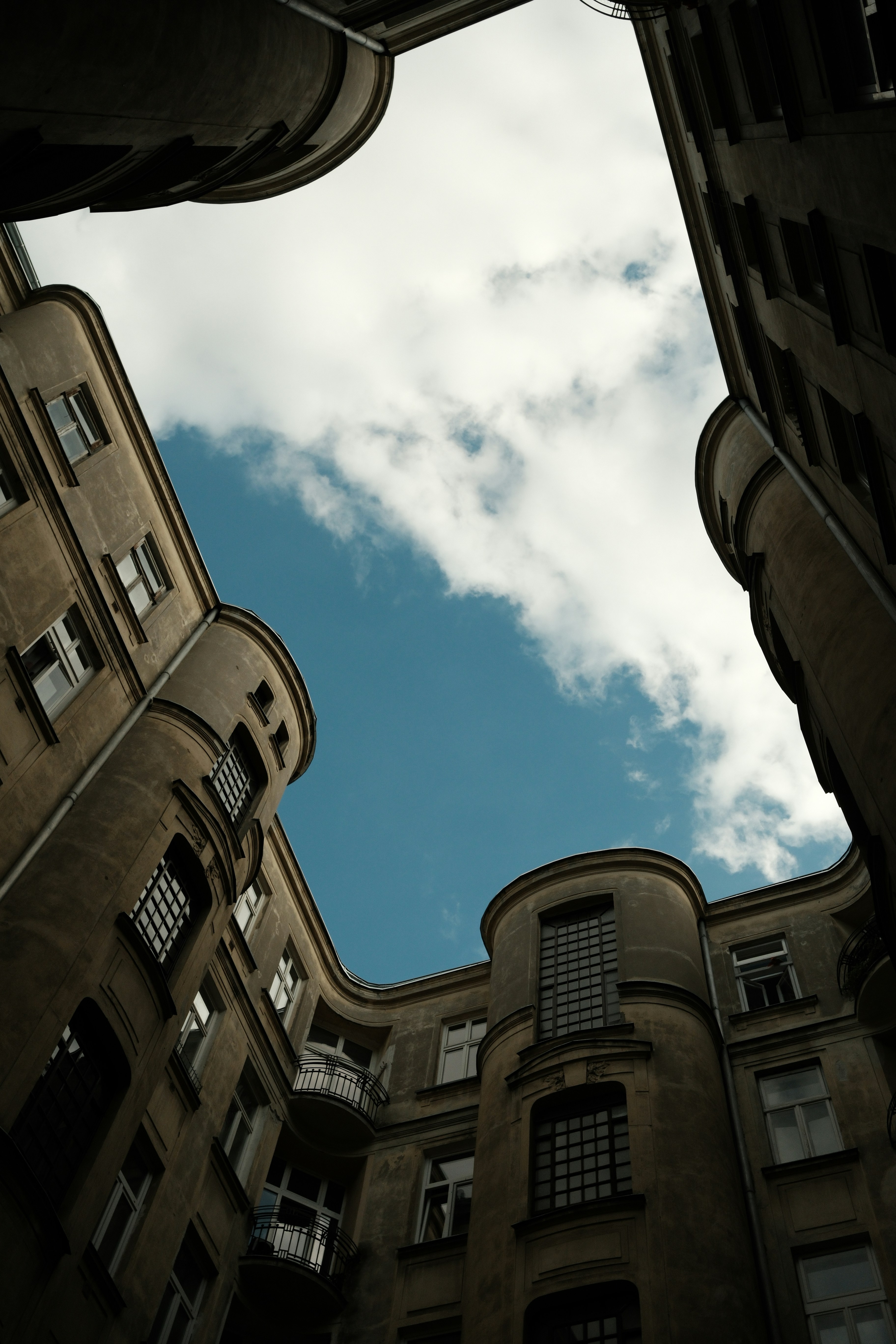 Skyward Courtyard: A Dying Light Between Historic Facades