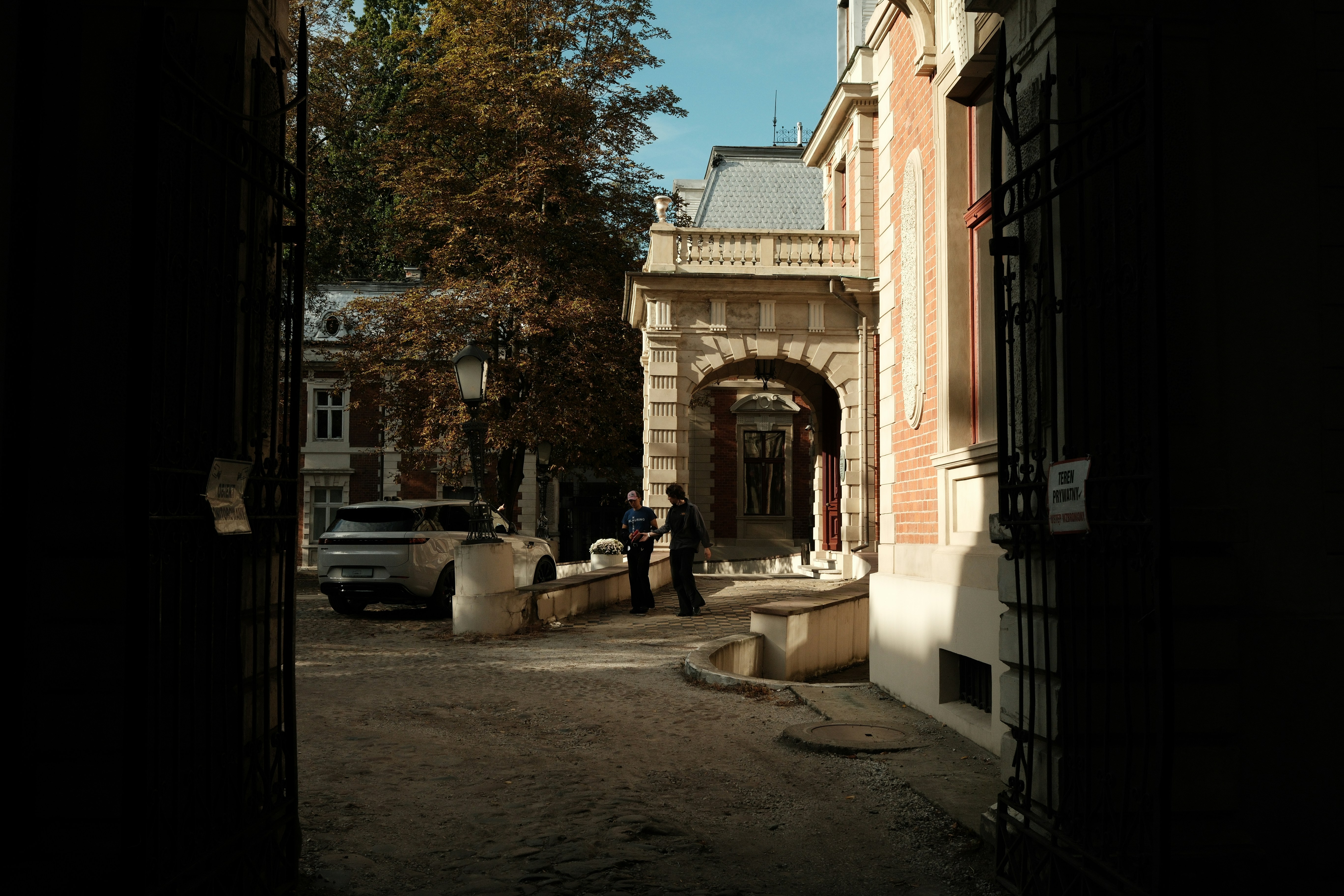 Portal of Evening Light: A Quiet Archway framed by Street Activity