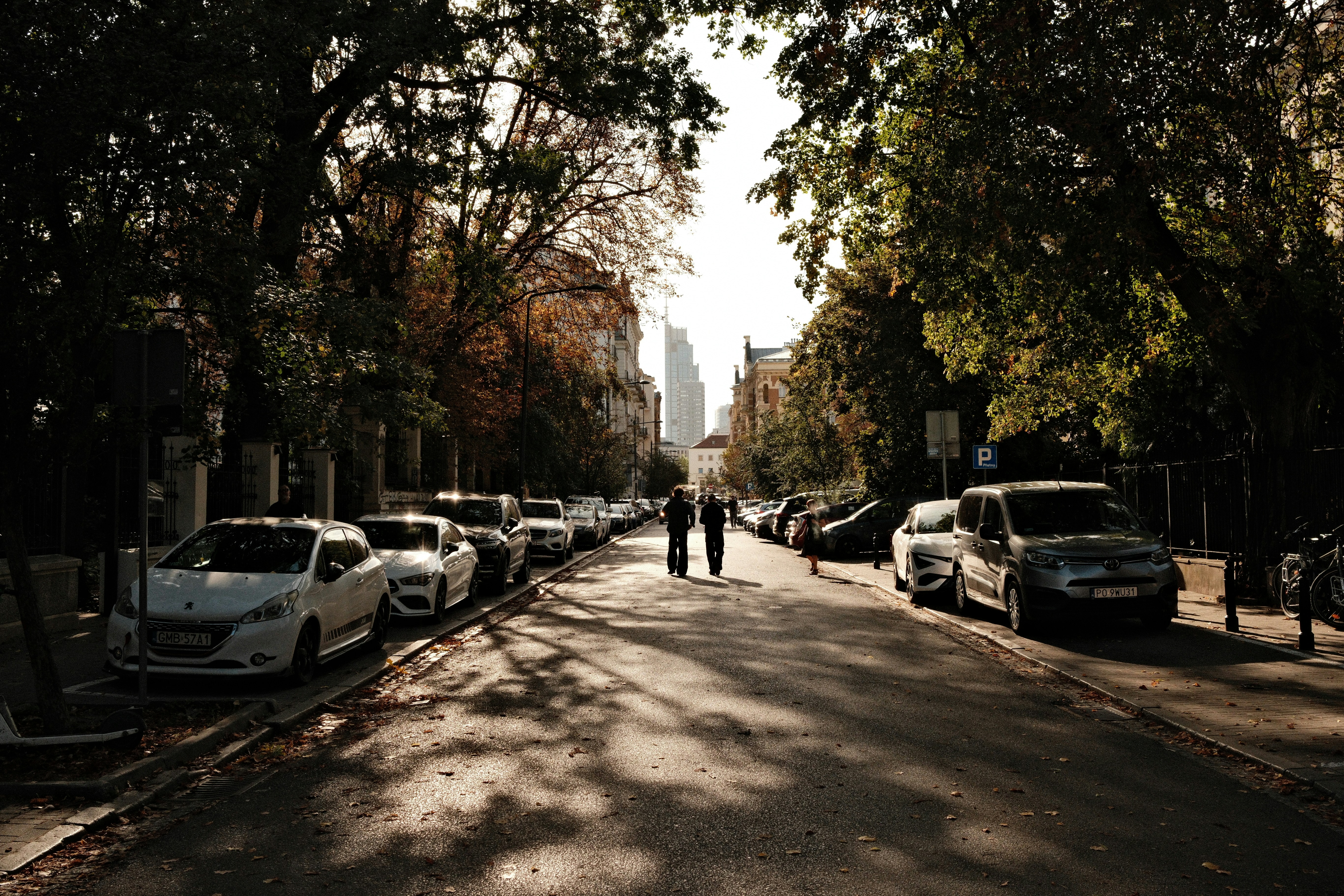 Quiet Arc: Two Figures Meet Under a Cityline