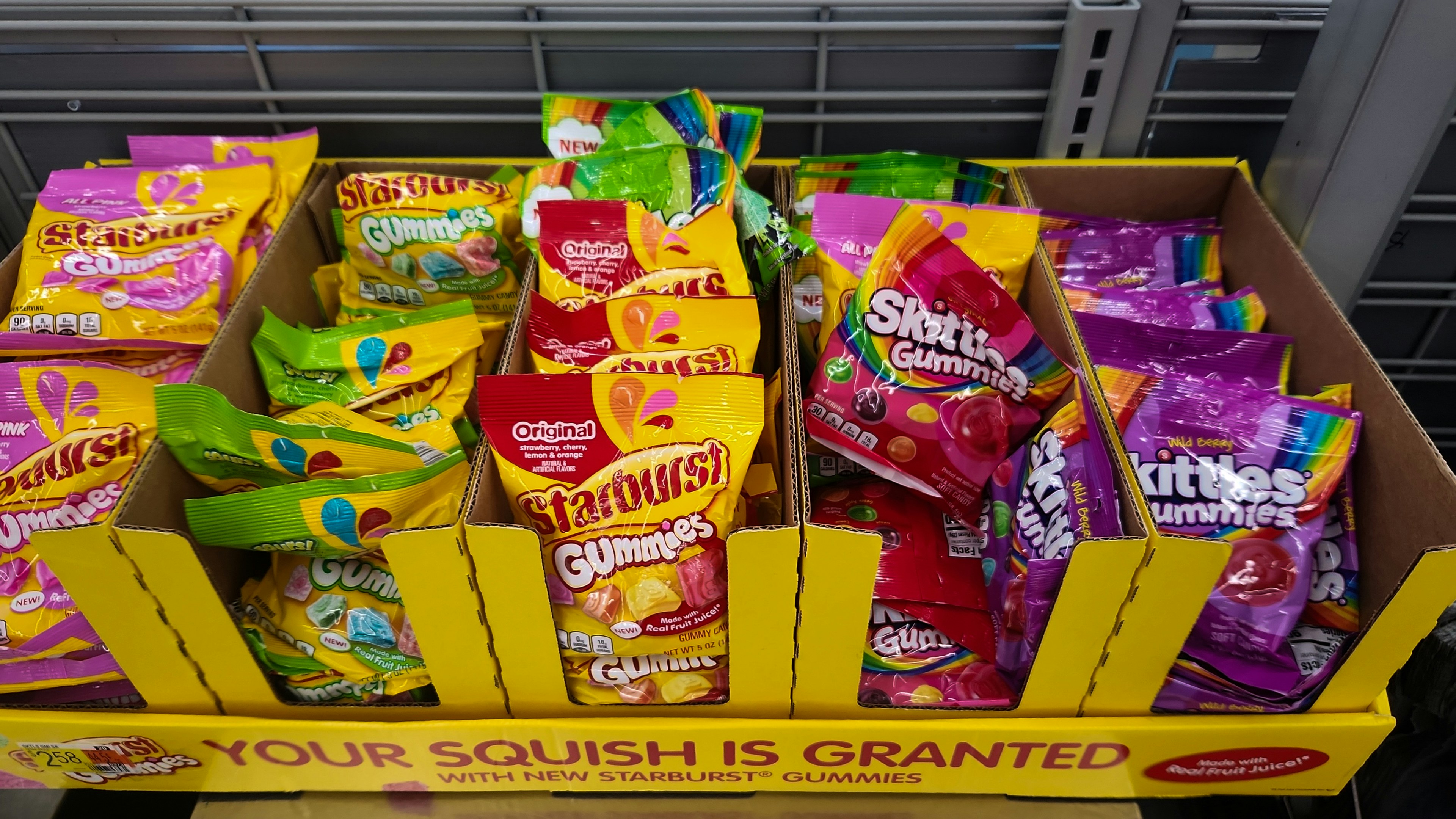 Sugary Rainbow: Colorful Gummy Assortment in Market Shelf Display