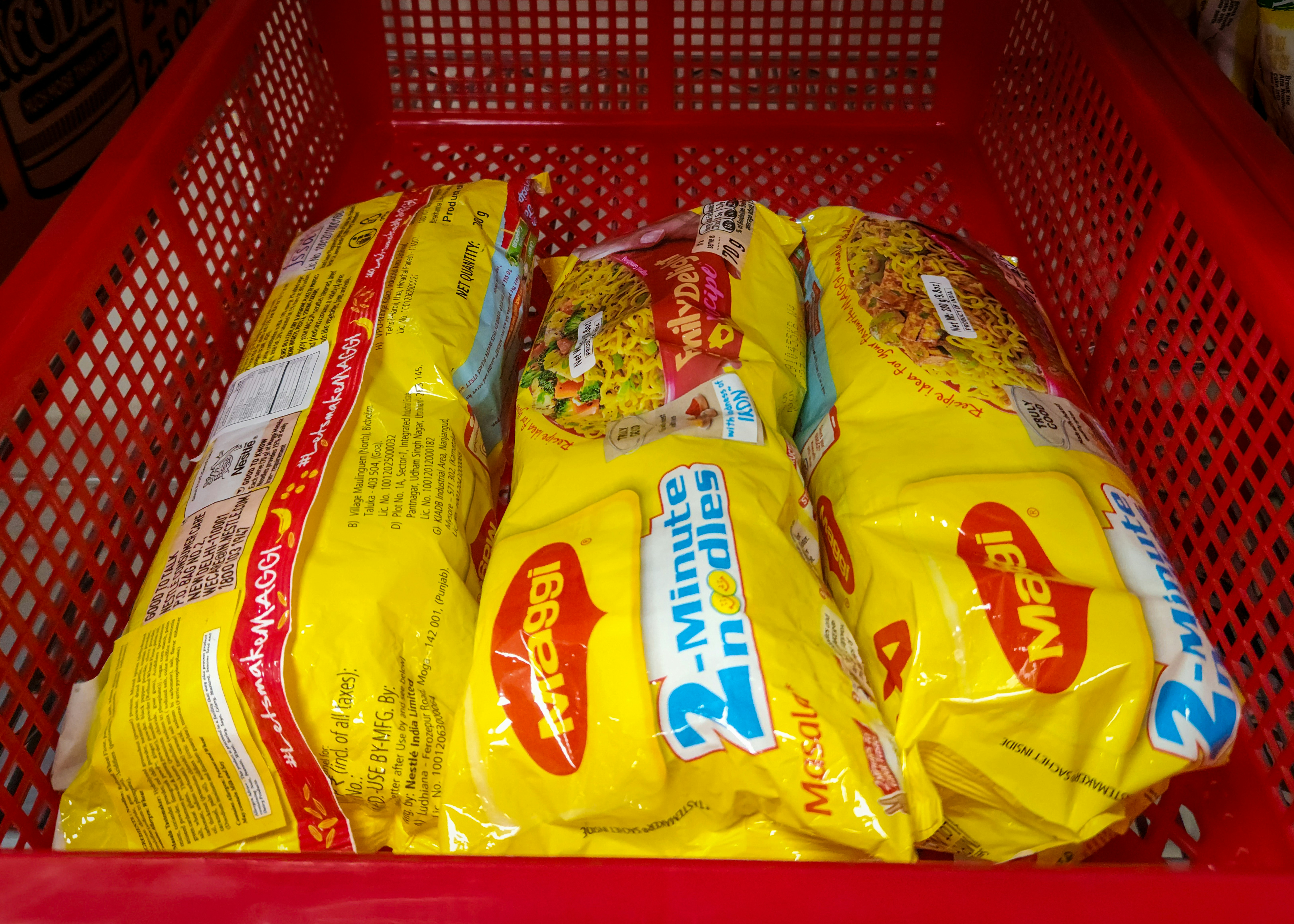 Bright Yellow Package Parade in a Red Grocery Basket