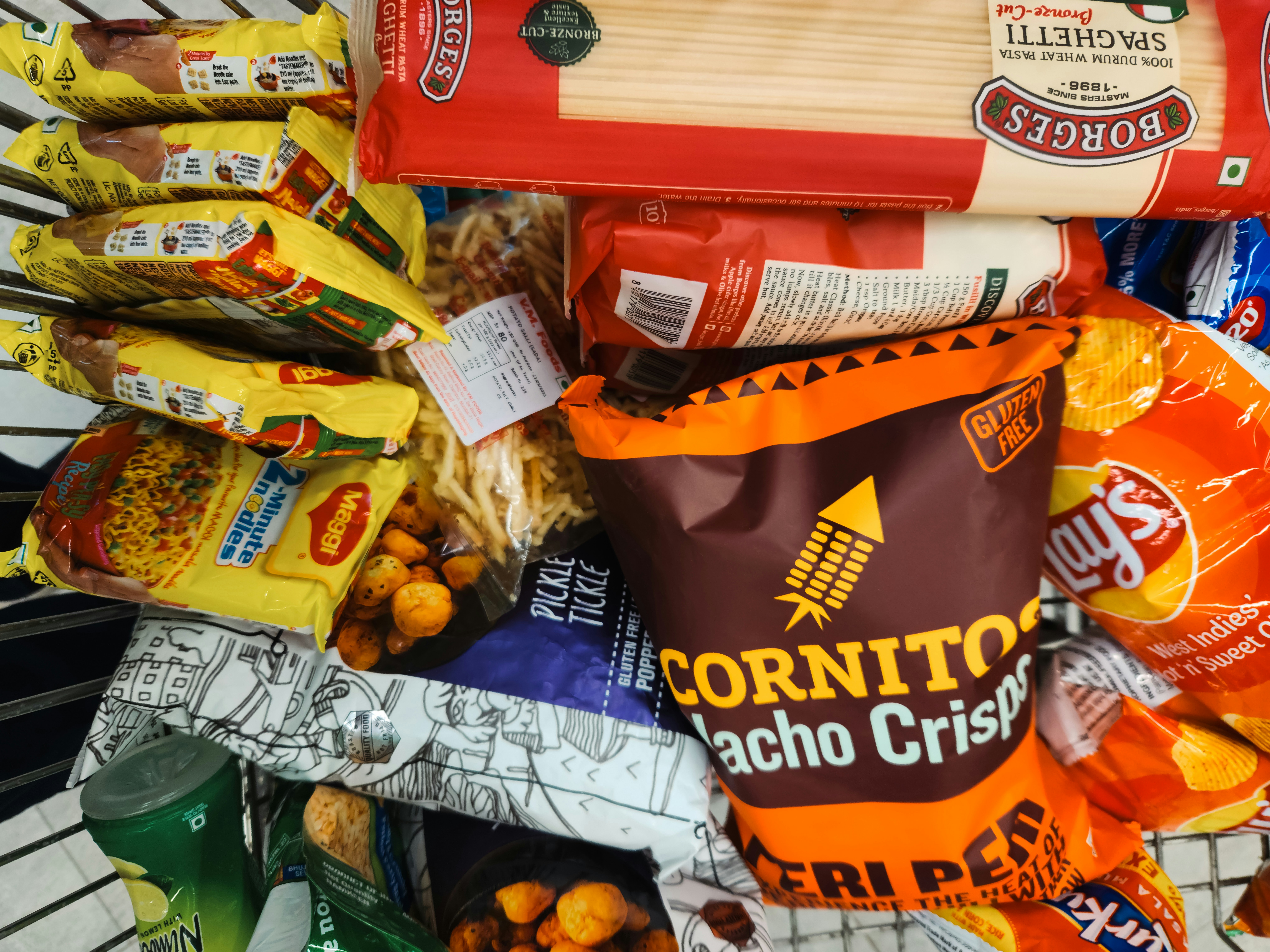 Bright Snack Aisle Collage: Cornitos Nacho Crisps Amid Multicolored Packets