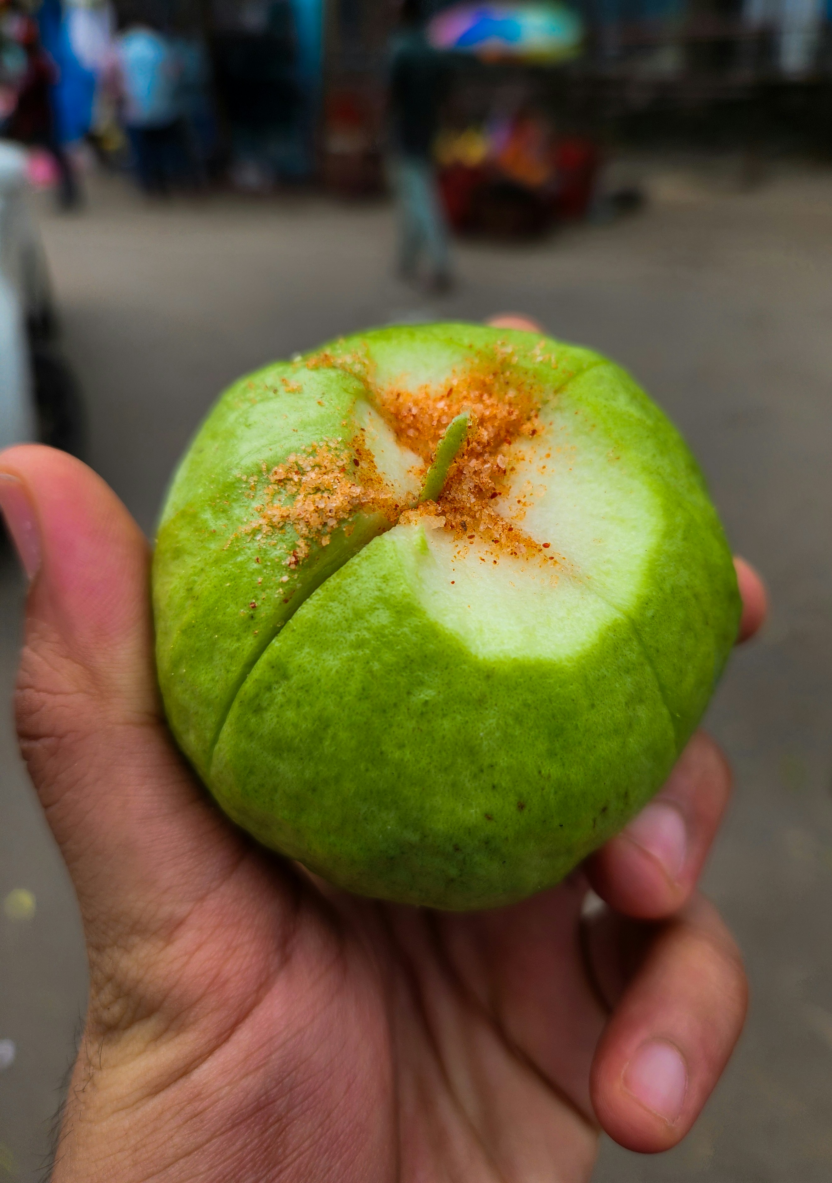 Handheld Green Apple: Close-Up Bite of Citrus-Softened Texture