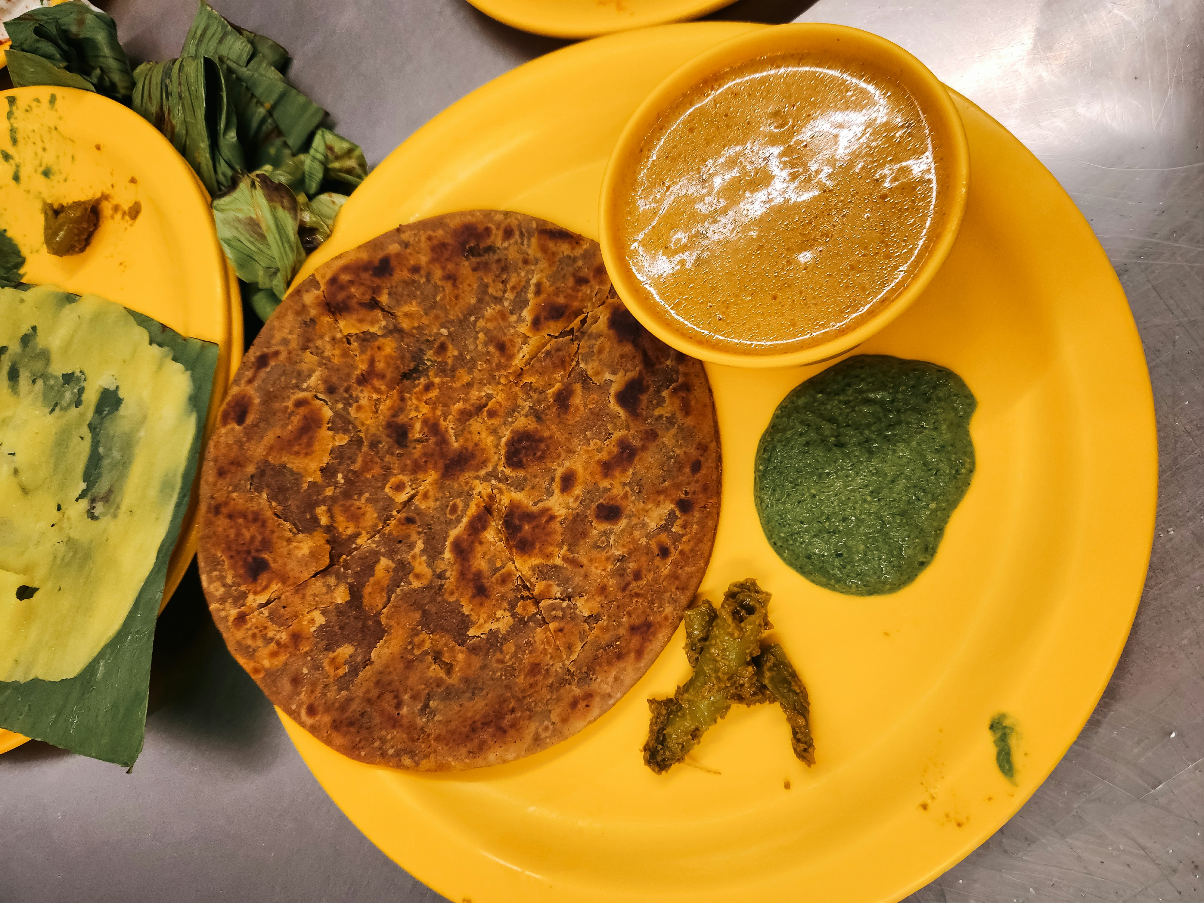 Golden Plate of Comfort: A Savory Flatbread Duo with Sauce and Greens