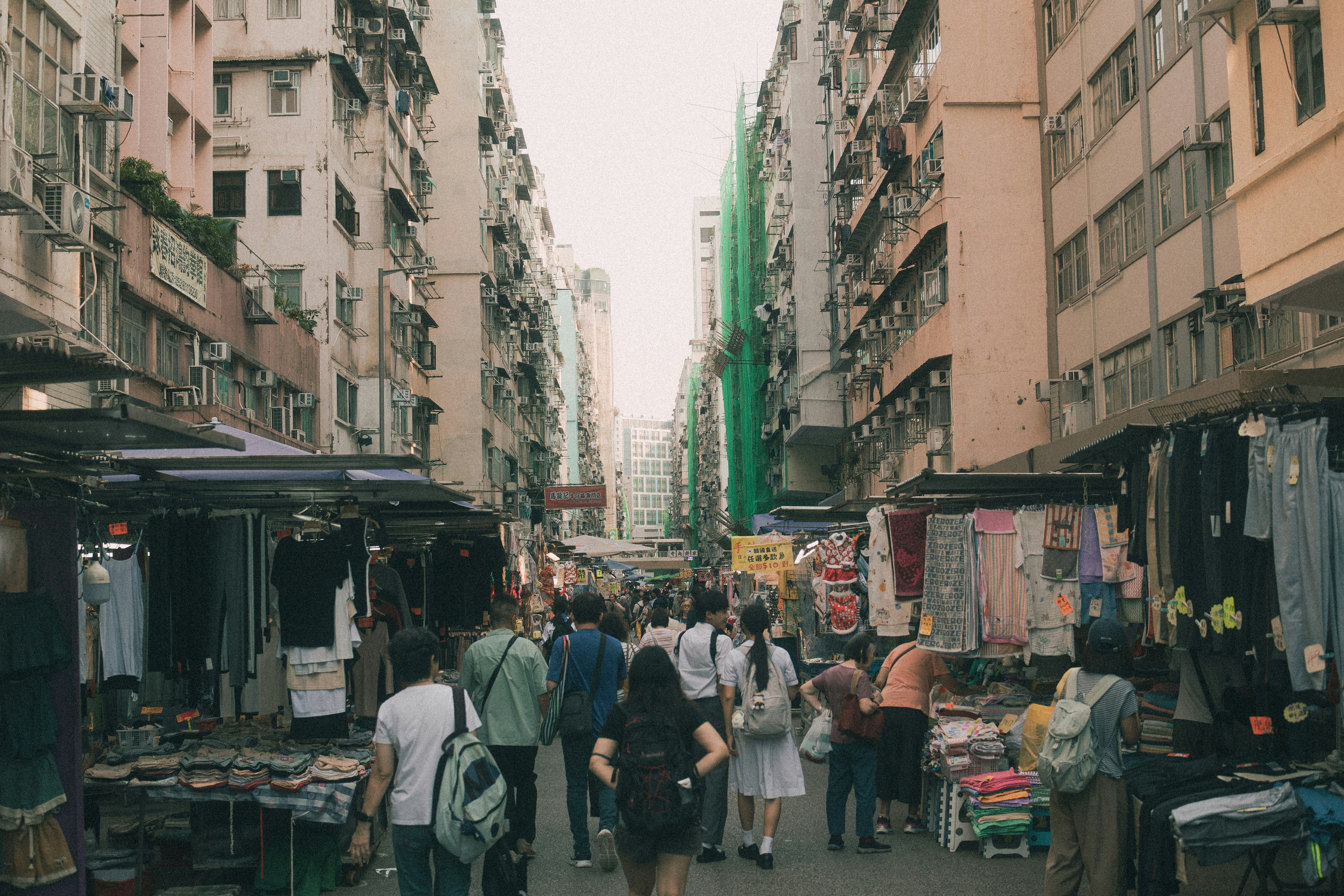 Crowded Market Corridor Amid Urban Facades
