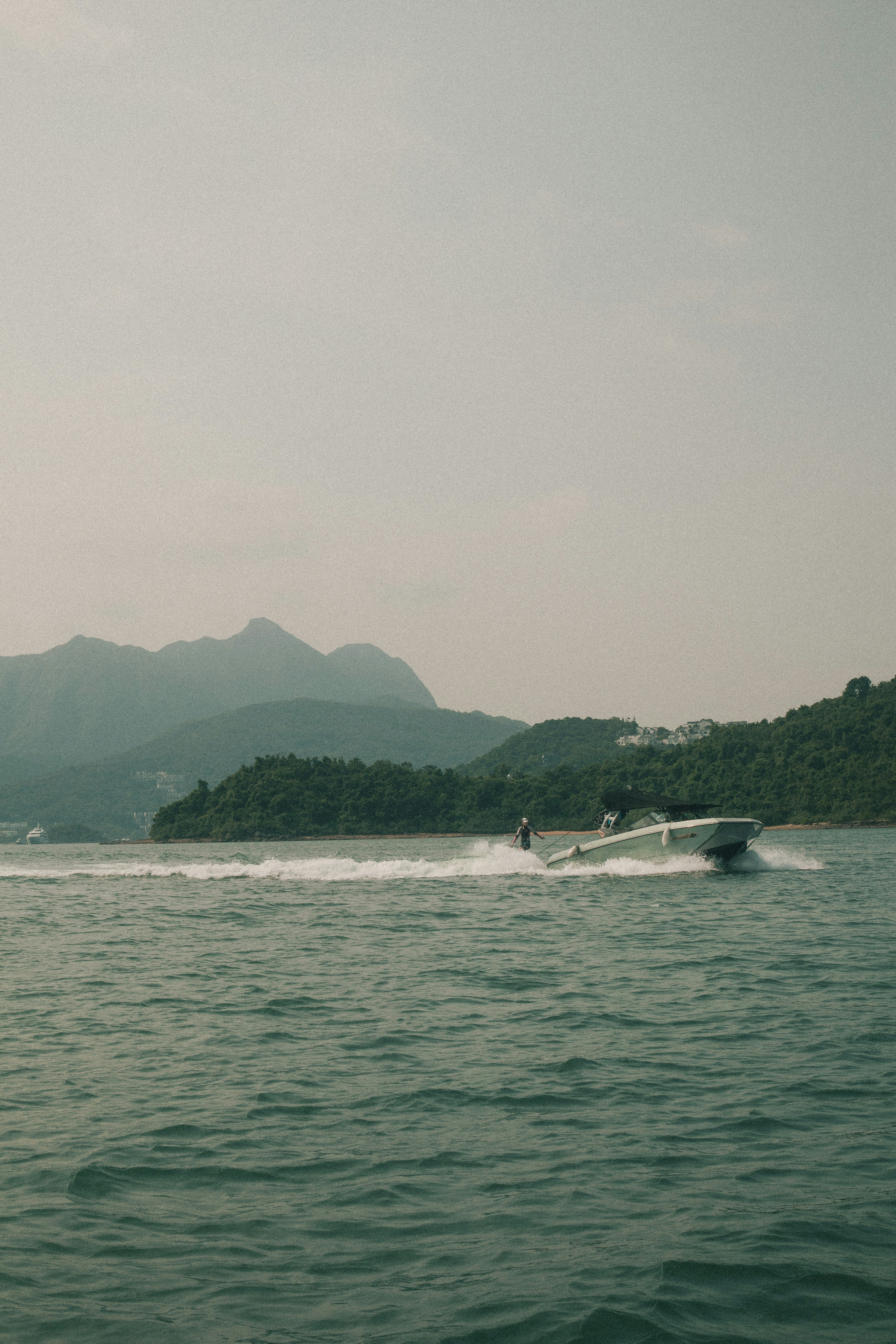Jet-Drive Silhouette: Boat Cutting Through Emerald Wake