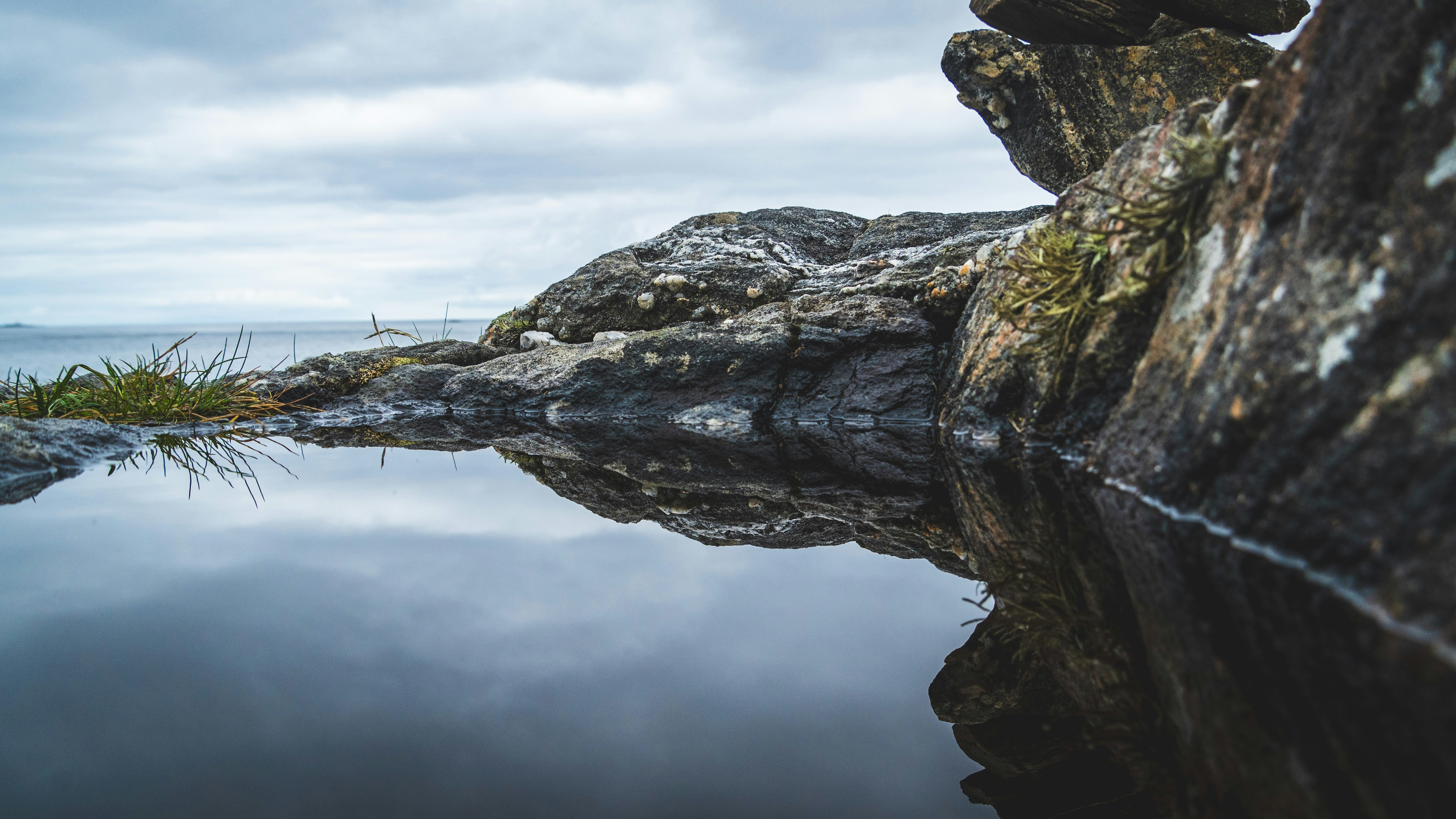Silent Tide Reflections Against Weathered Rocks