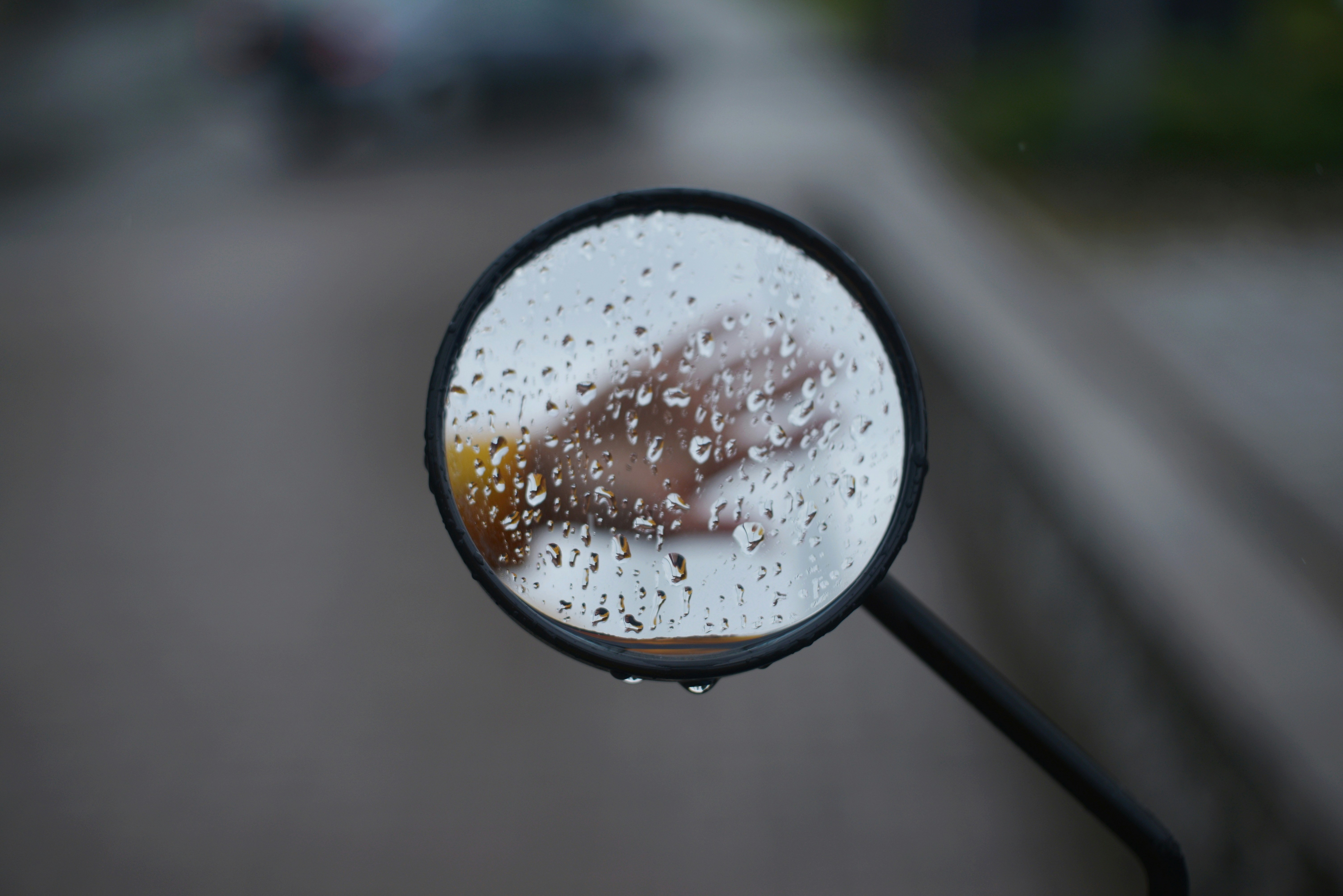 Raindrops on the Round Mirror: A Street Scene Reflected