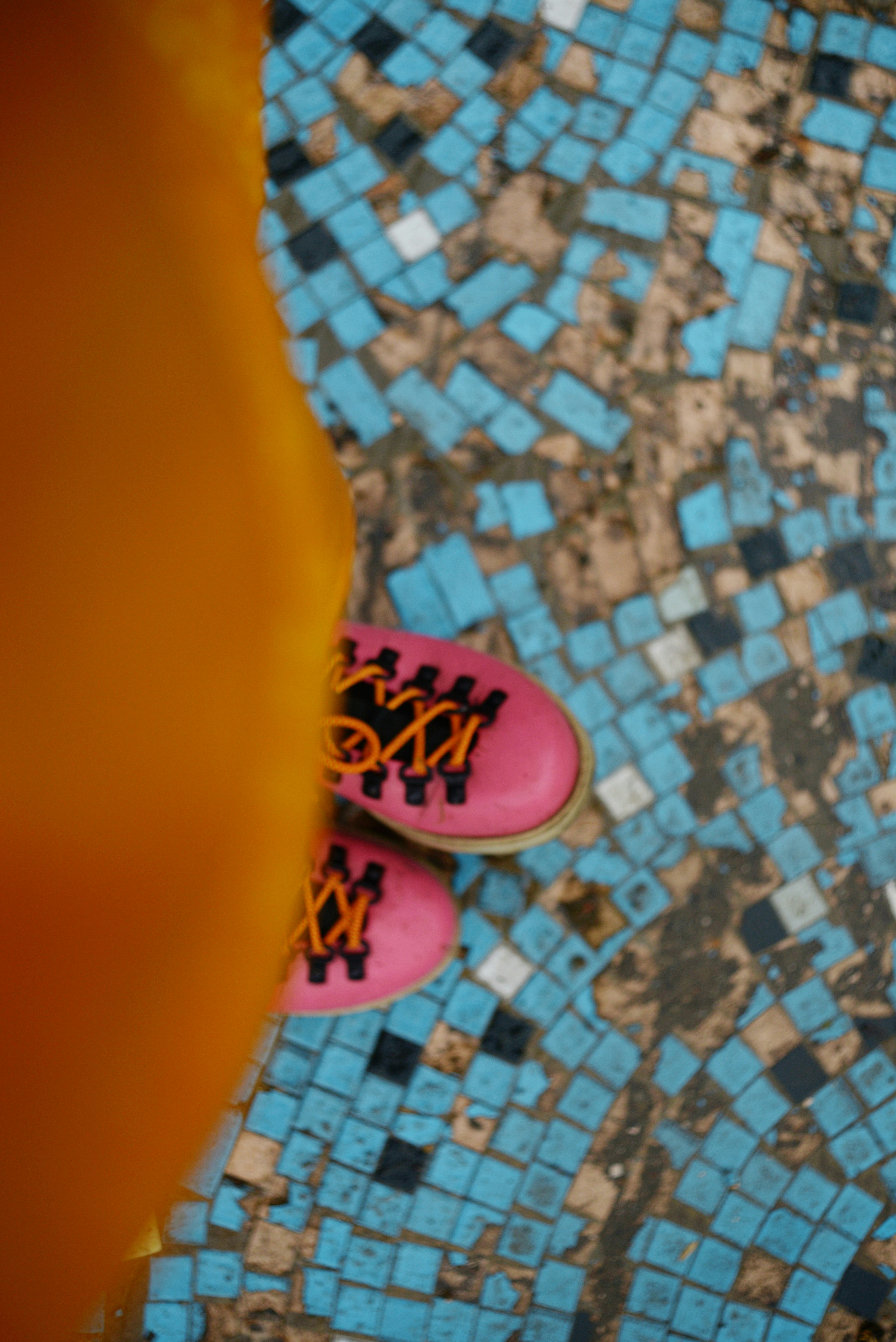 Pink Shoes on a Mosaic Path: A Peek at Youthful Footsteps