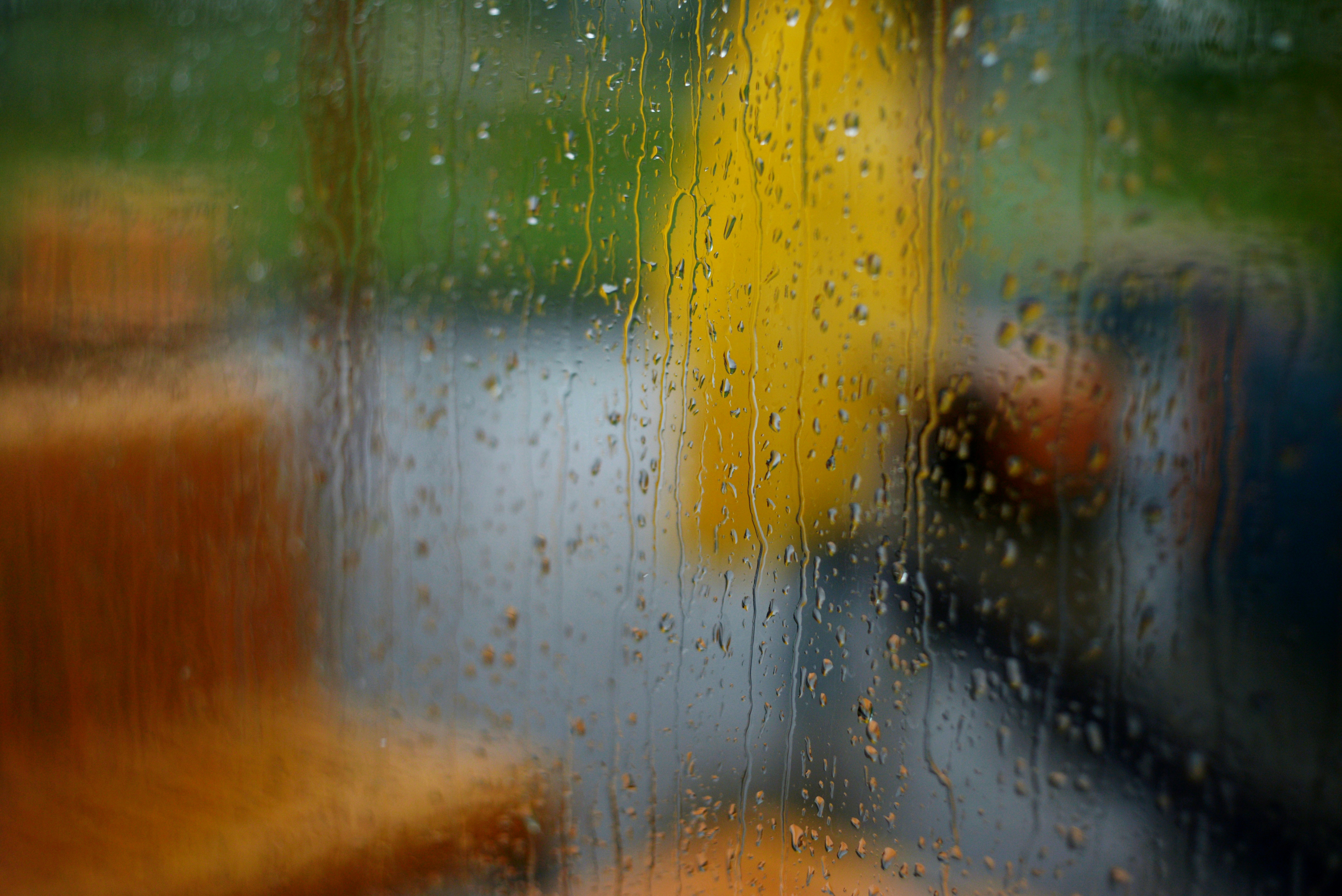 Drizzle Streaks on a Dim Café Window