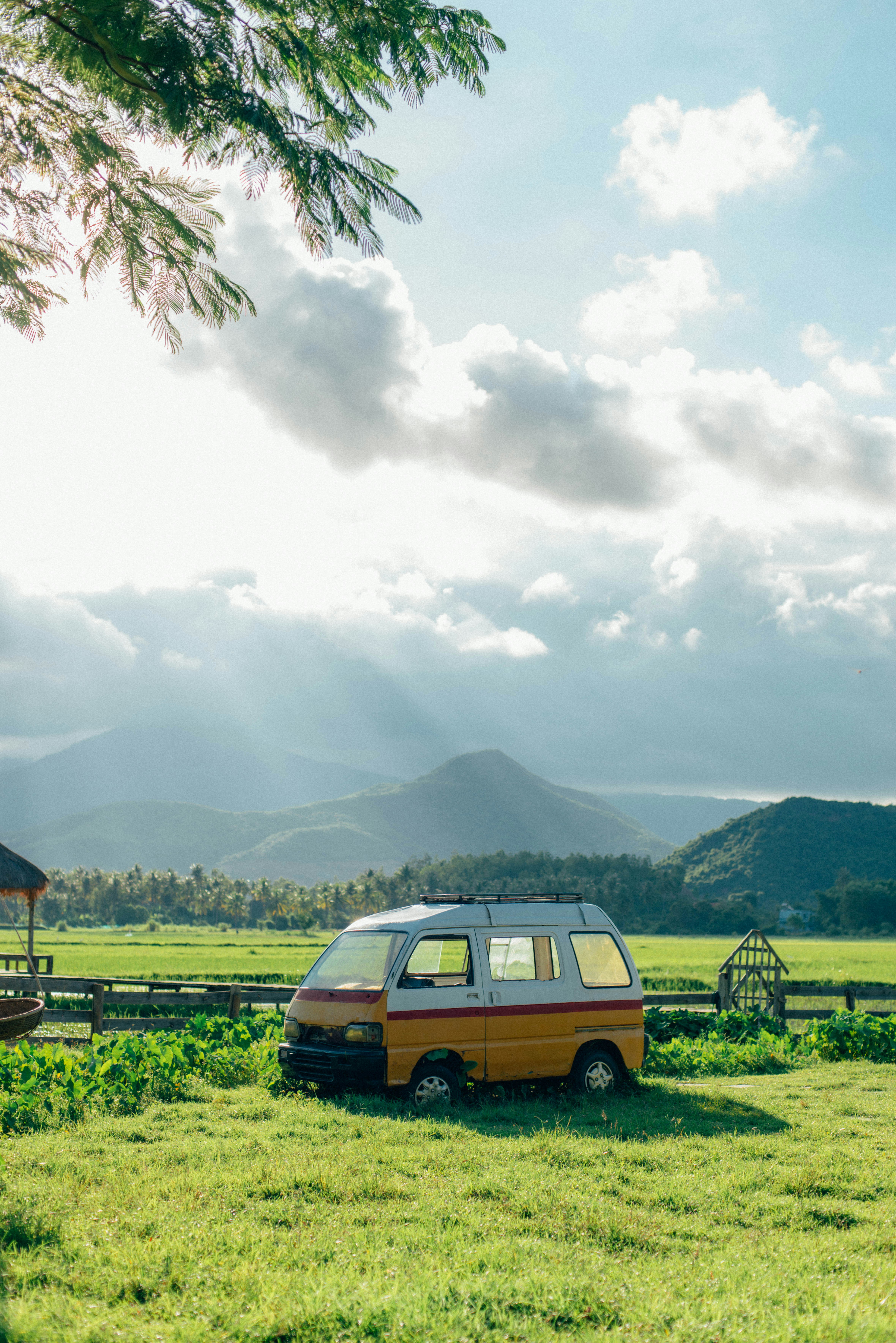 Sunlit Meadow and Vintage Van beneath Whispering Clouds