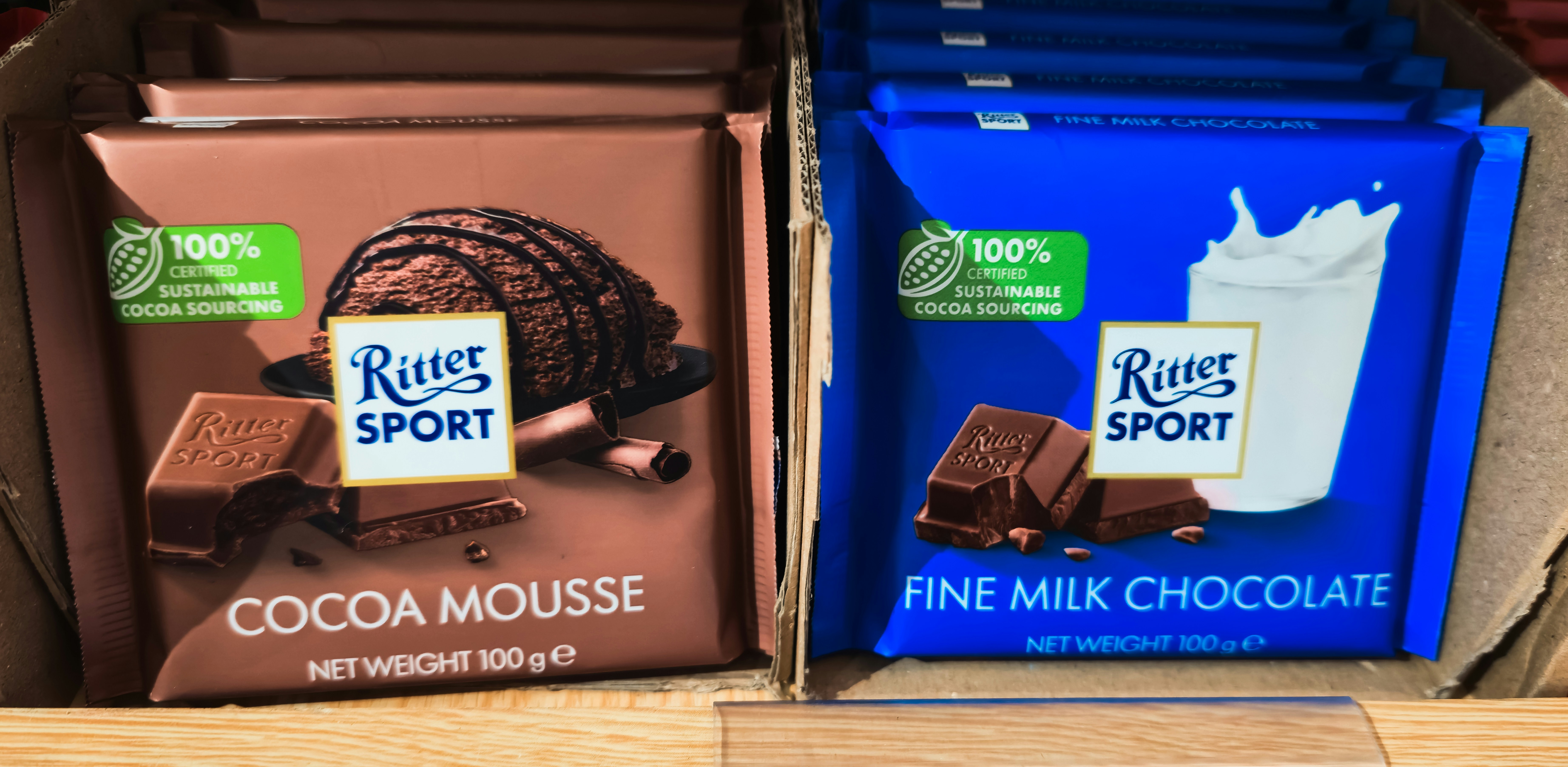 Two Ritter Sport Blocks: Cocoa Mousse and Fine Milk Chocolate stake their color in a retail display