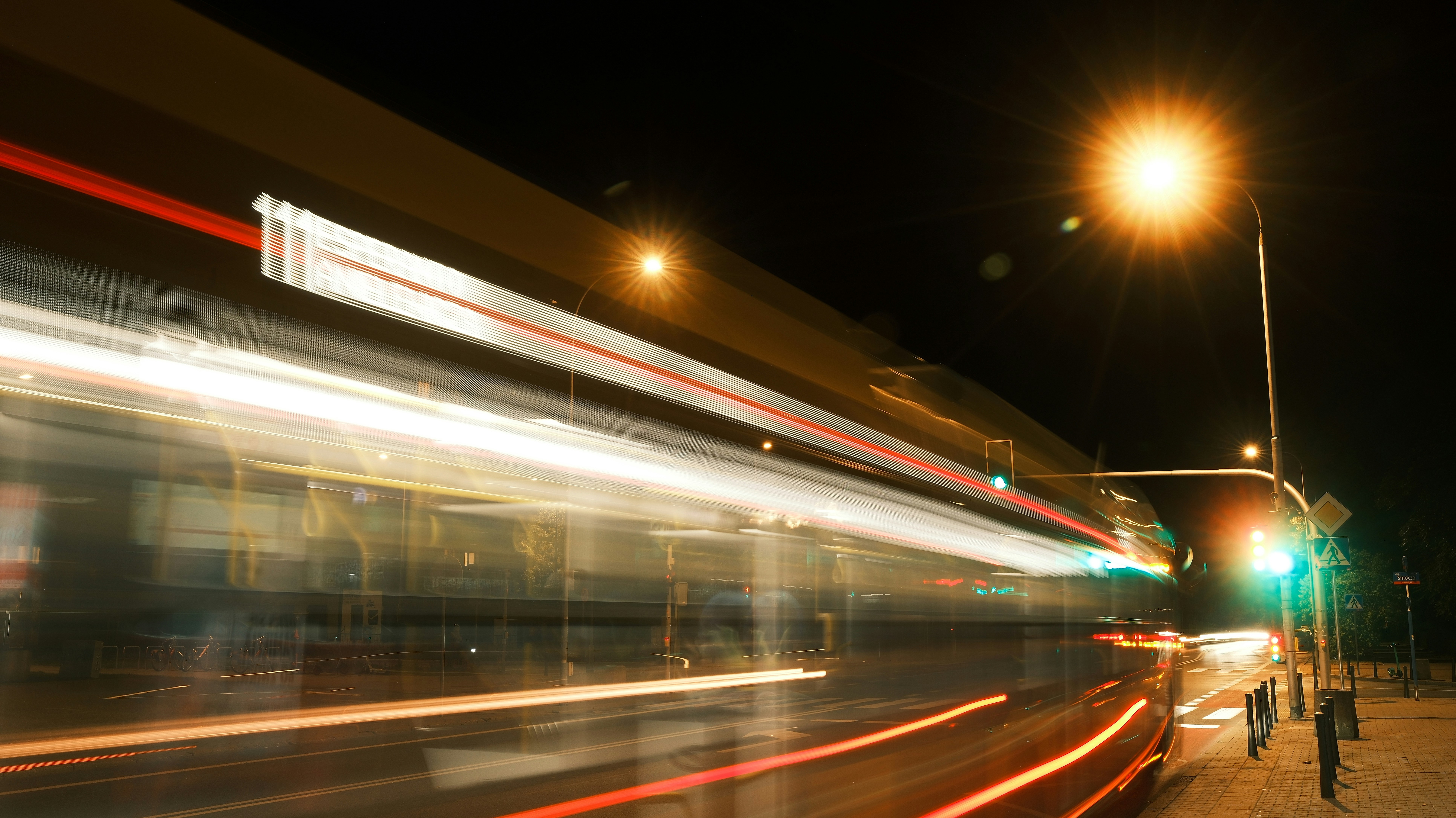 Night Bus in Motion: Light Trails Across an Urban Street