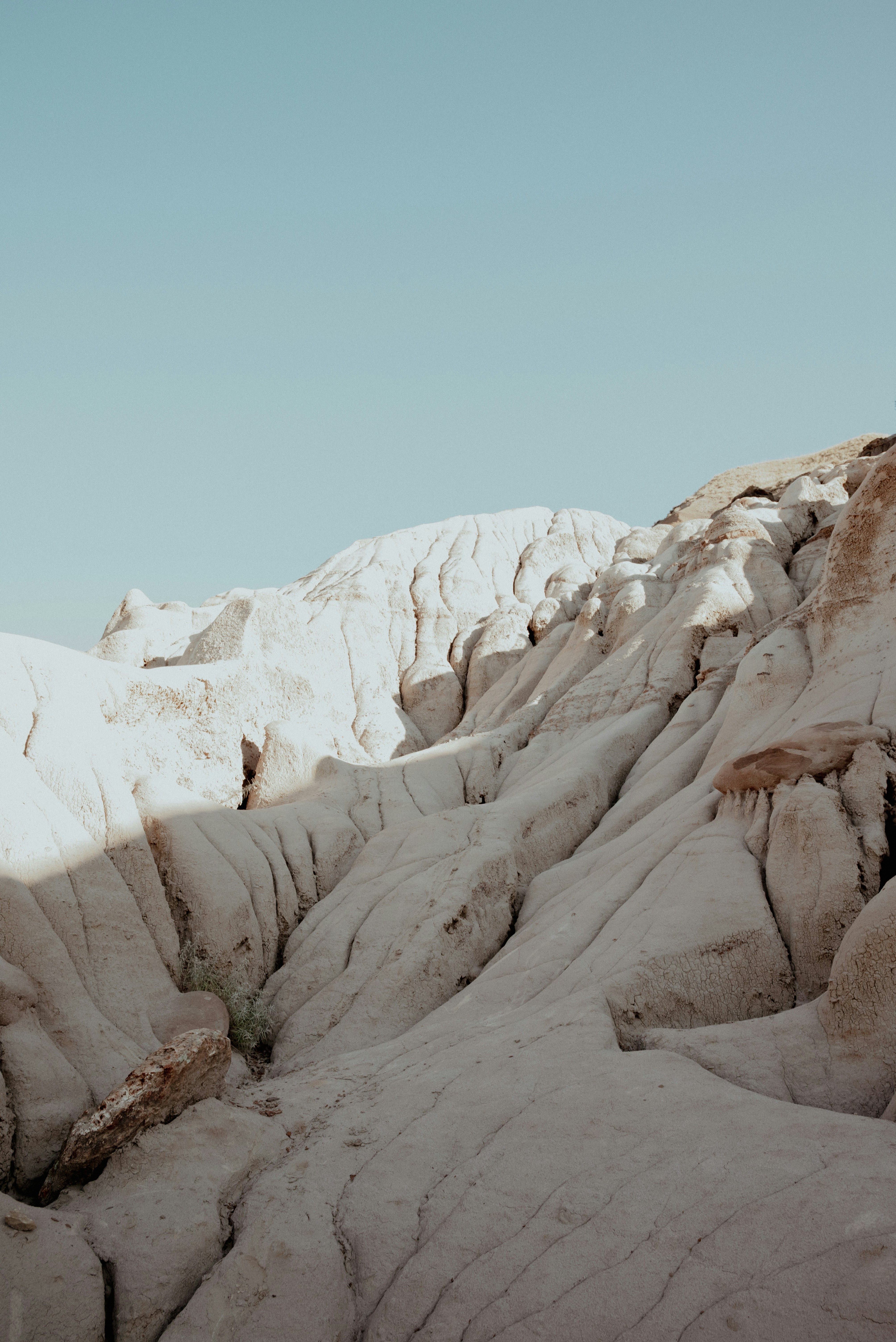 Bleached Ridge Dawn: Weathered Caldera Forms Under Pale Sky