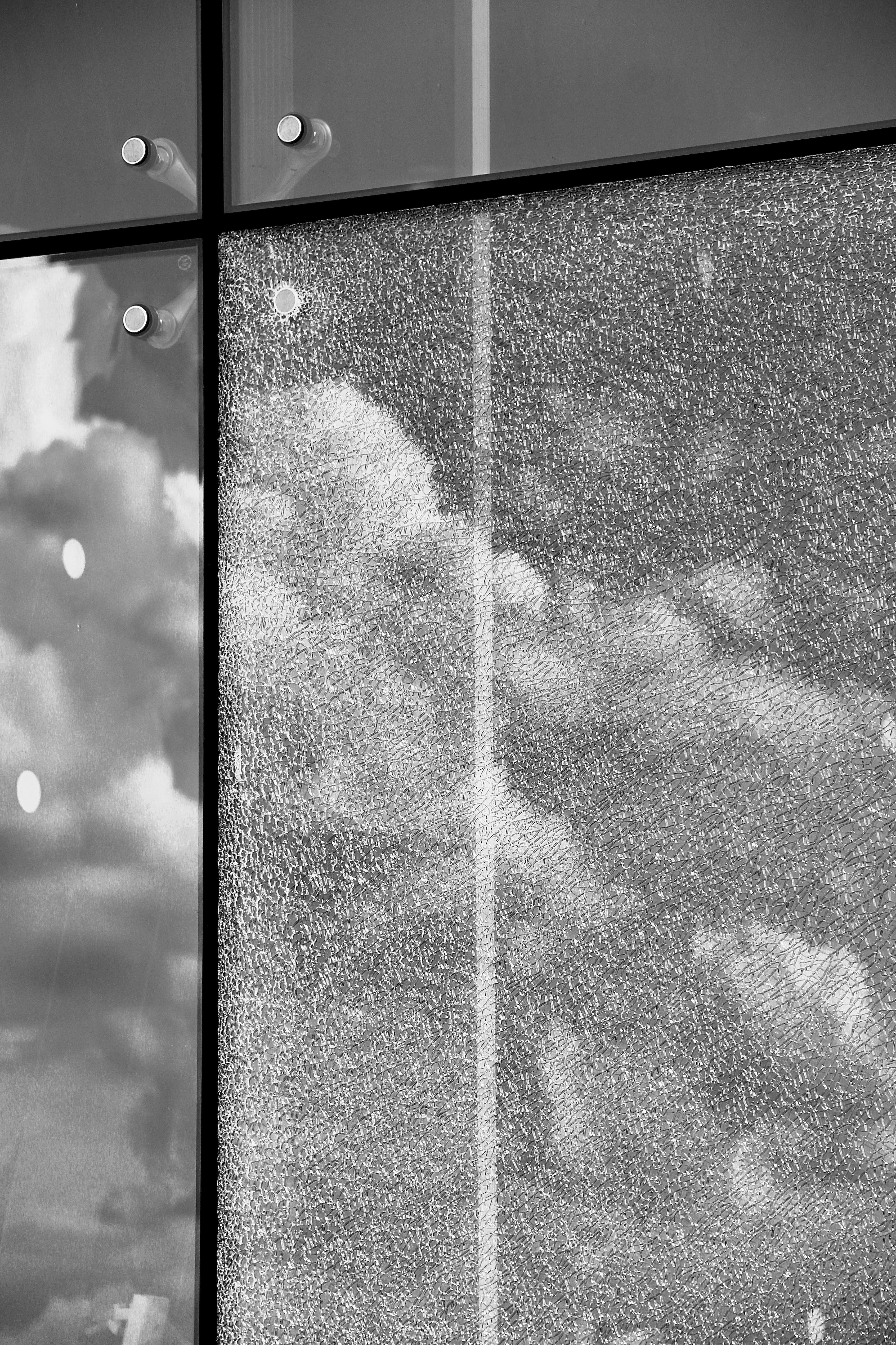 Cornered Glass: Frosted Panels and Cloud Reflections