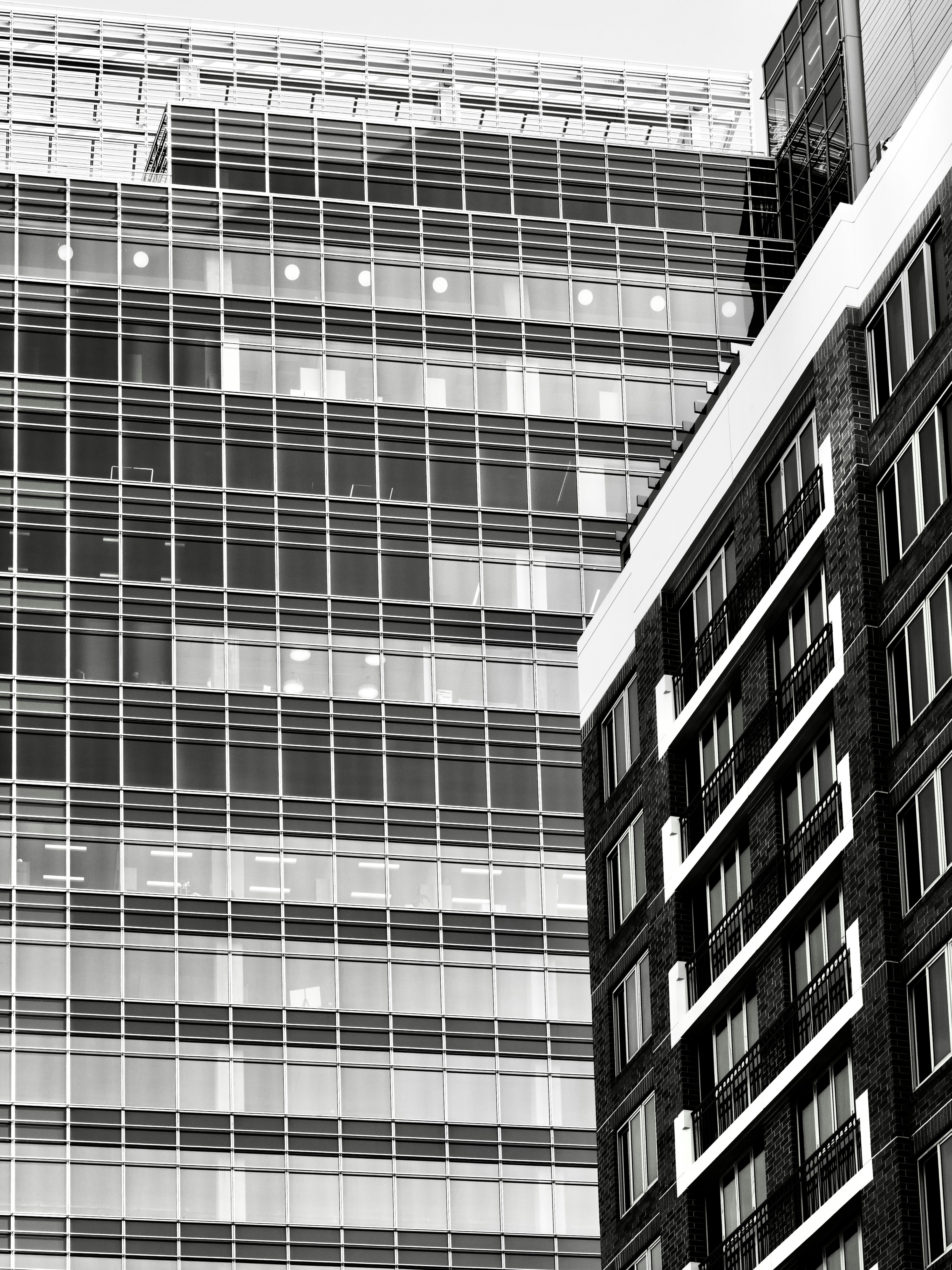 Geometric Facade Duet: Intersecting Grids on Glass and Brick