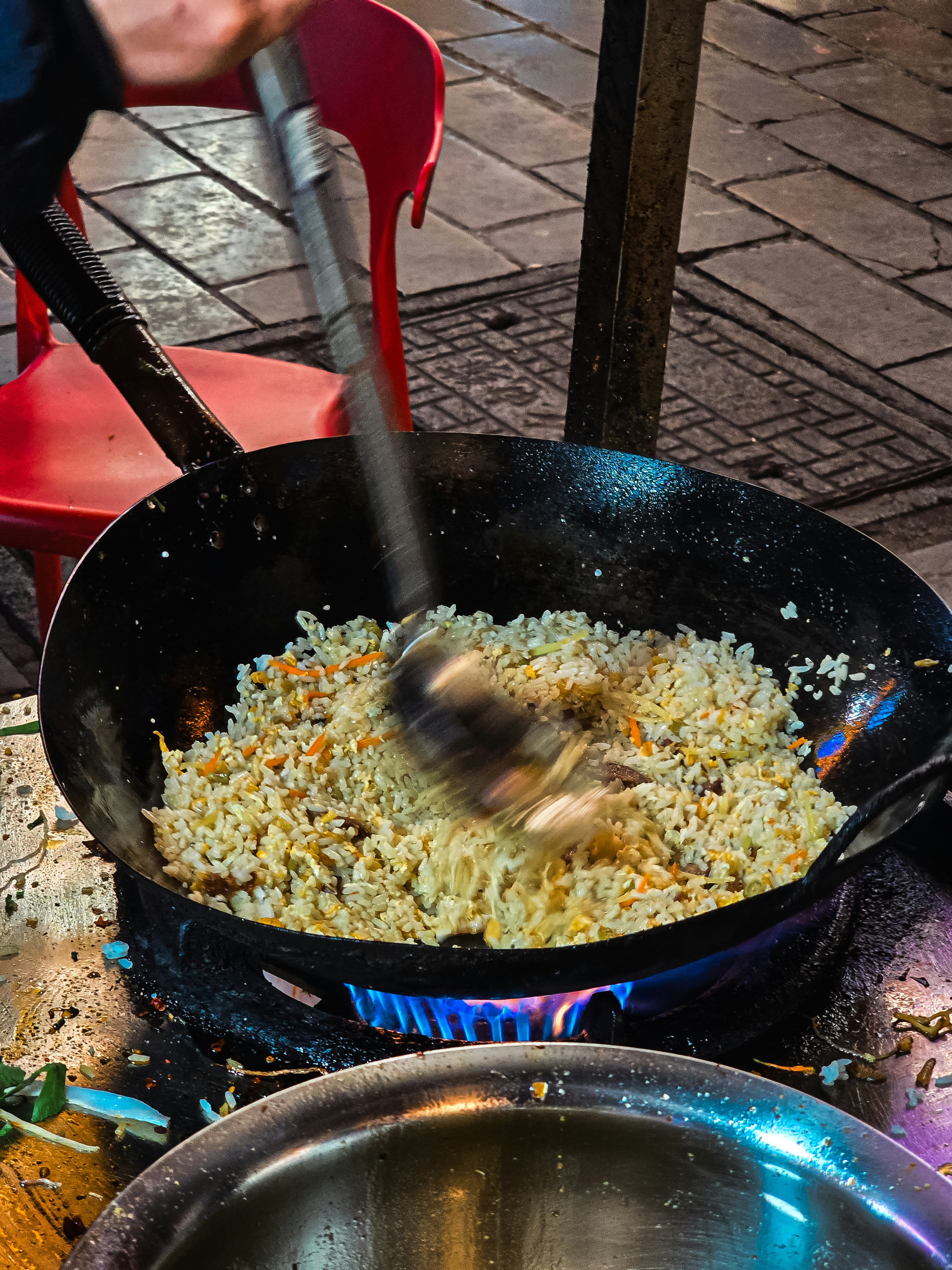 Stirring wok: fried rice in a sizzling street kitchen