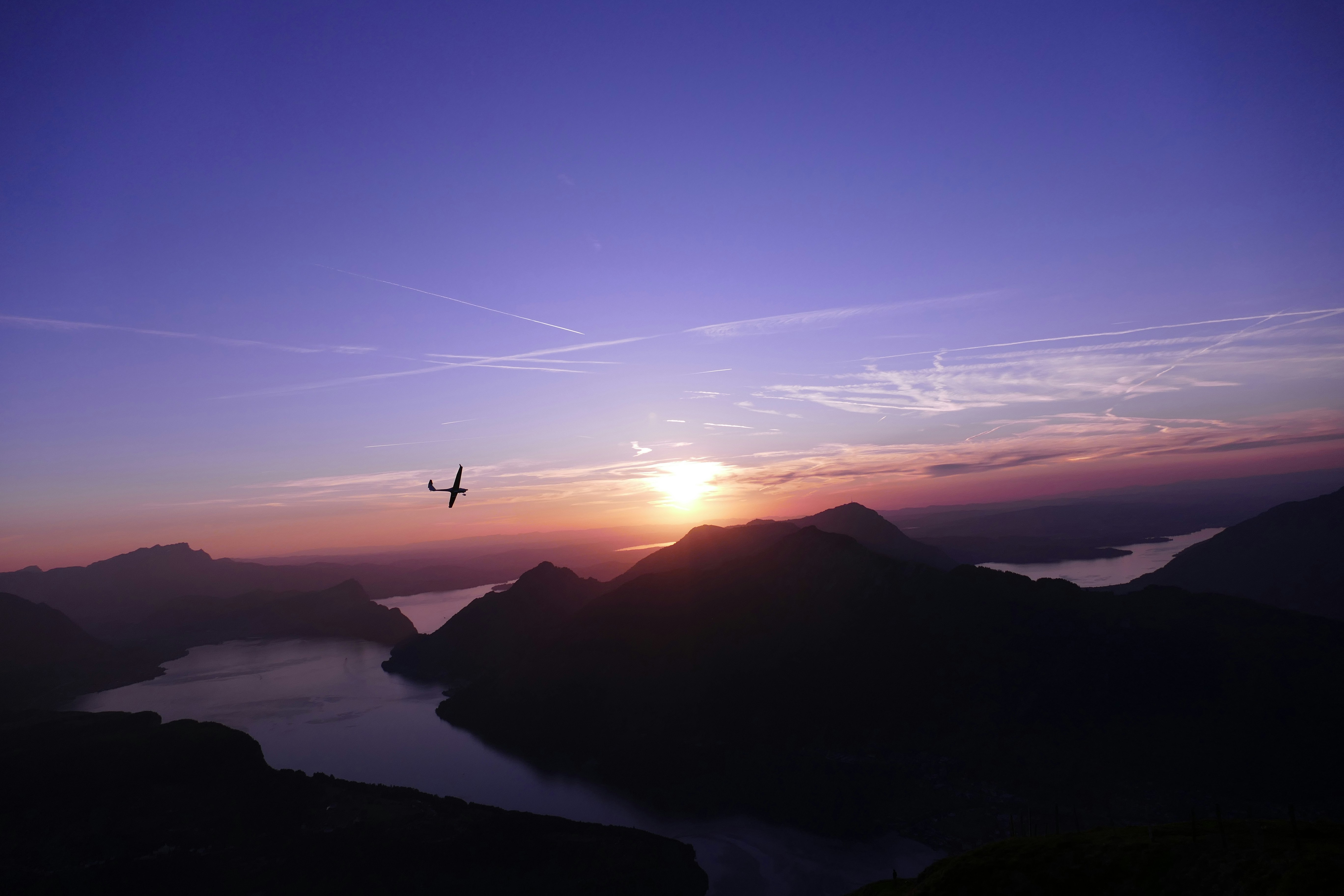 Sunlit Ridge and Soaring Silhouette at Dusk