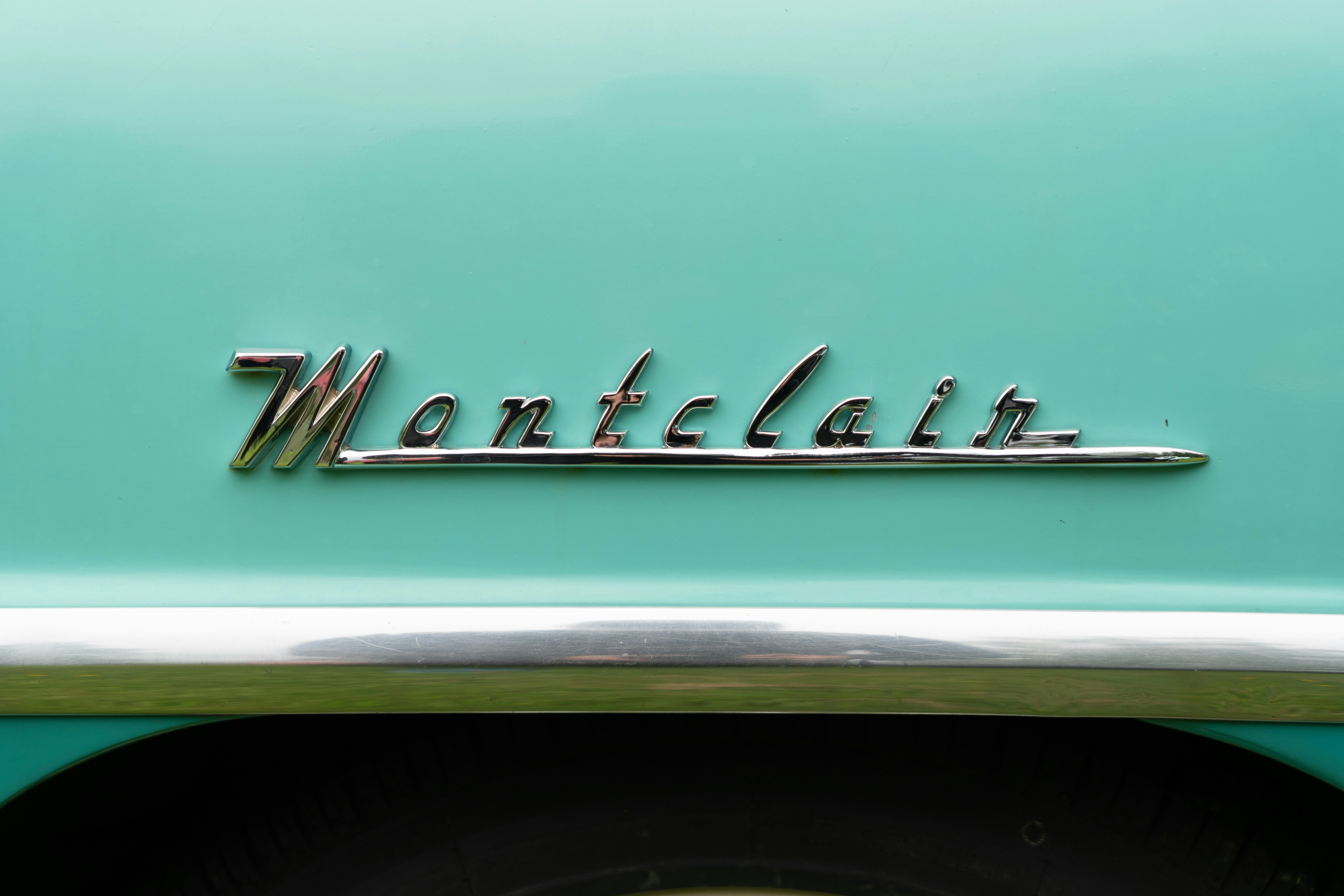 Minted chrome on chrome: the Montclair badge resting above teal chrome