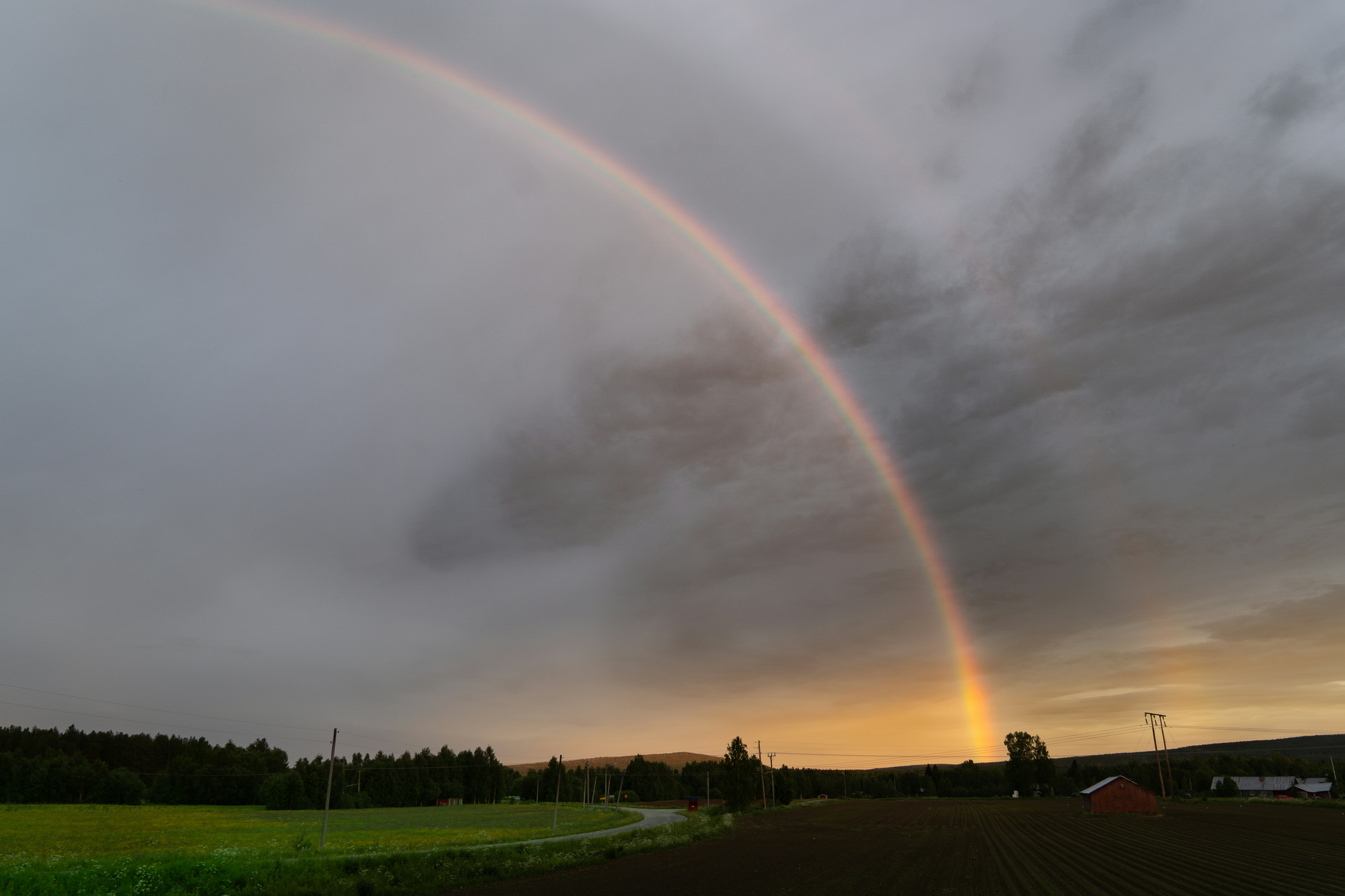 Double Rainbow Over a Quiet Farmland at Dusk