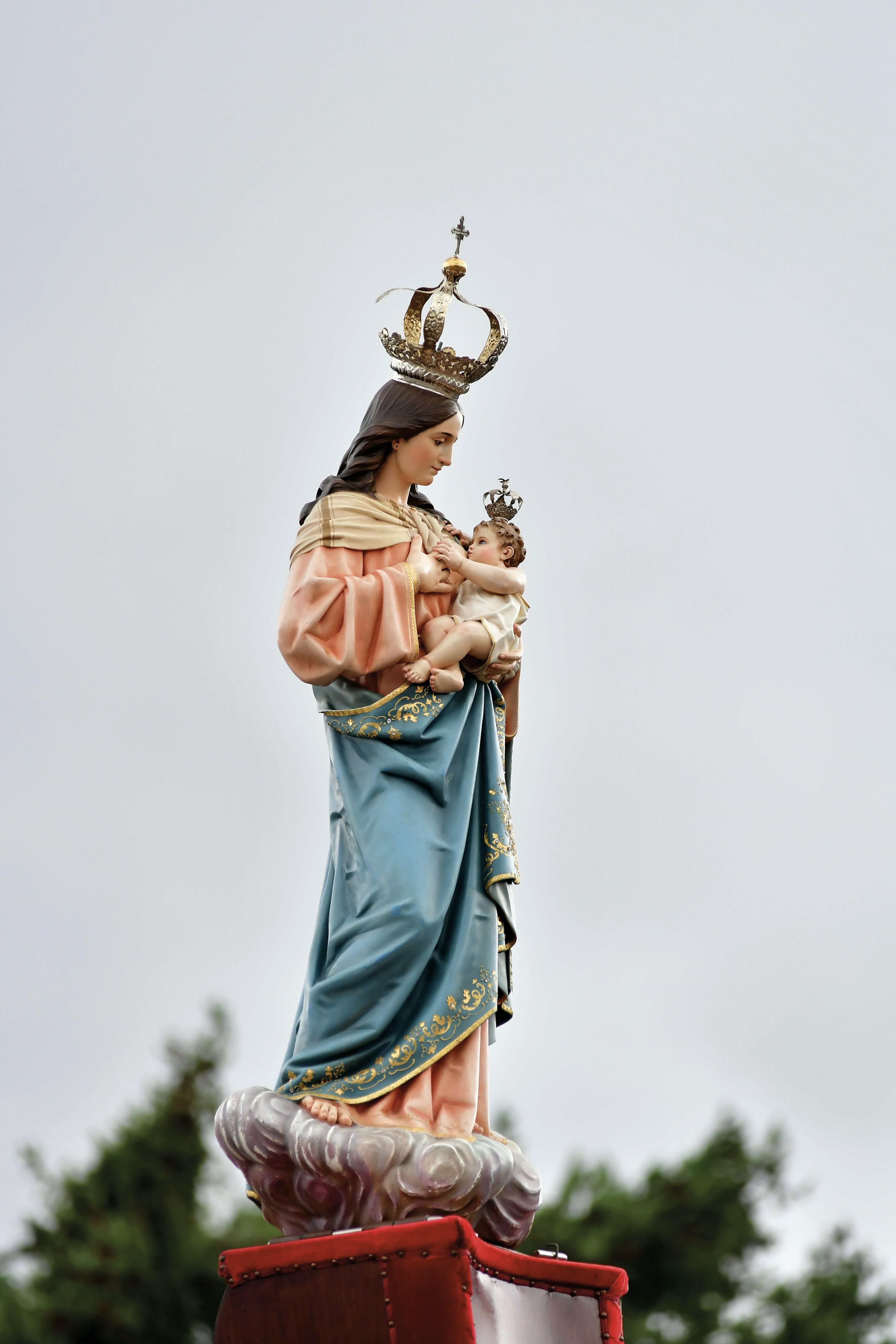 Crowned Virgin: A Statuesque Madonna Against the Open Sky