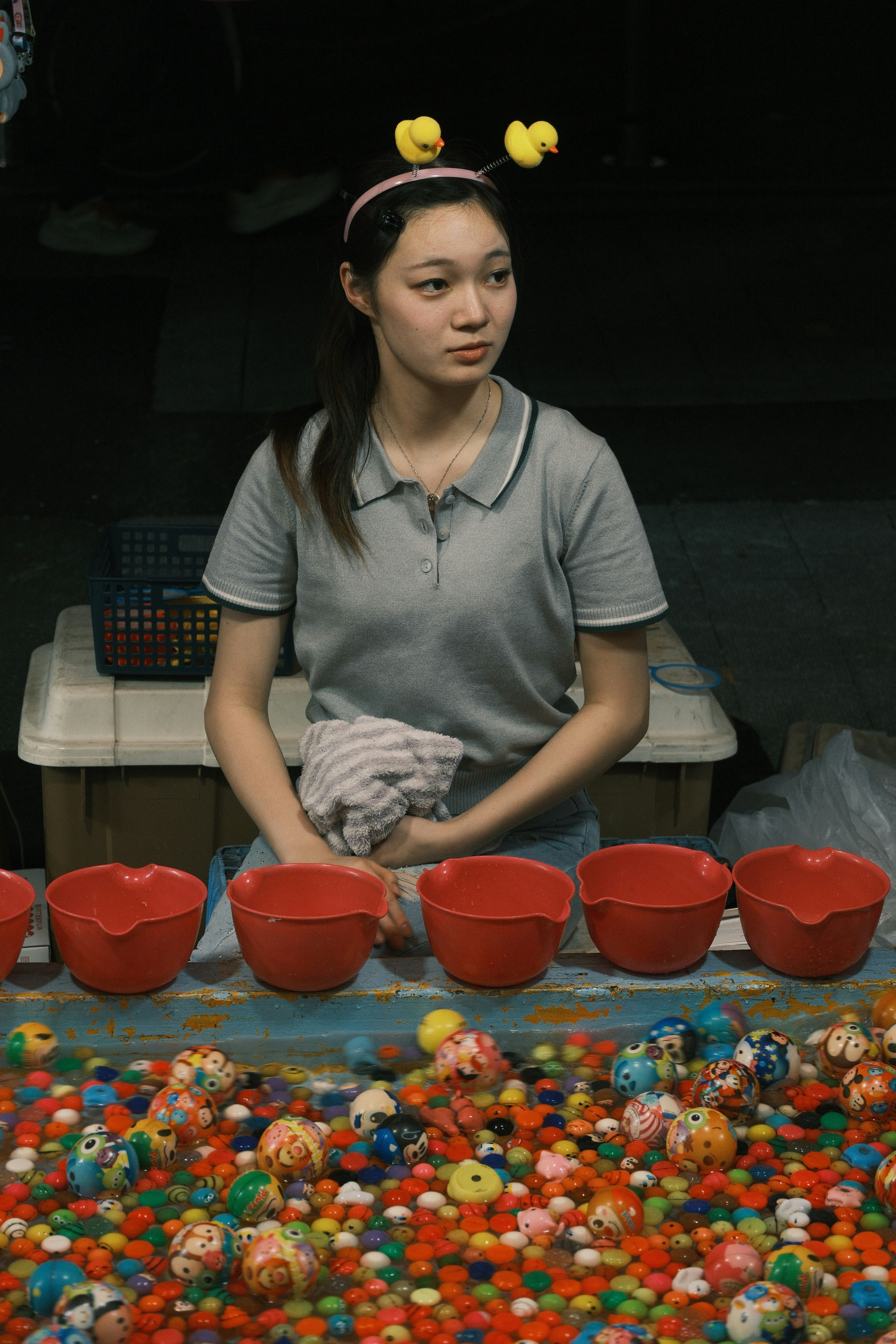 Among the Floats: A Quiet Moment at the Colorful Stall