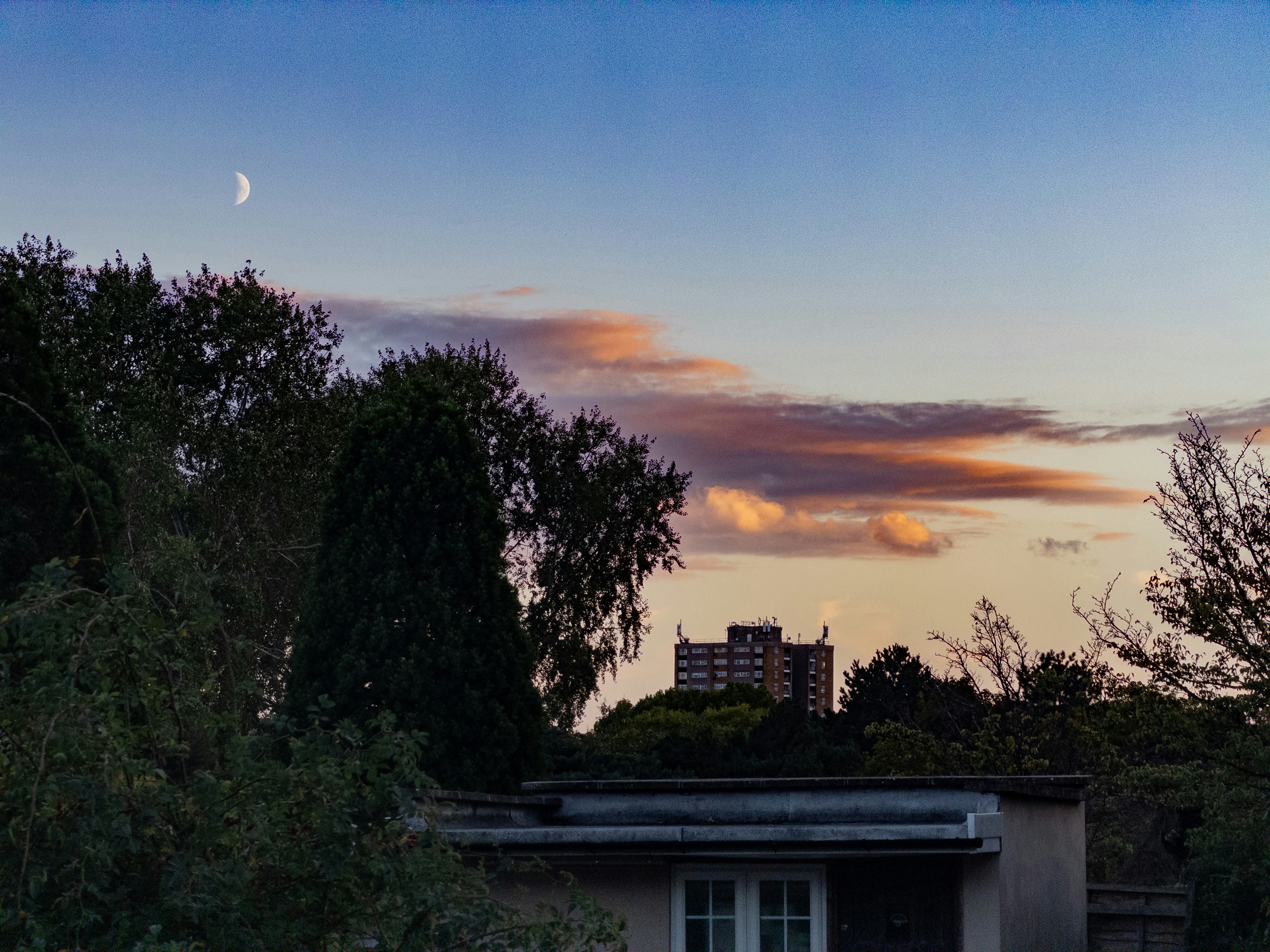 Crescent Moon Over Quiet Suburban Skyline