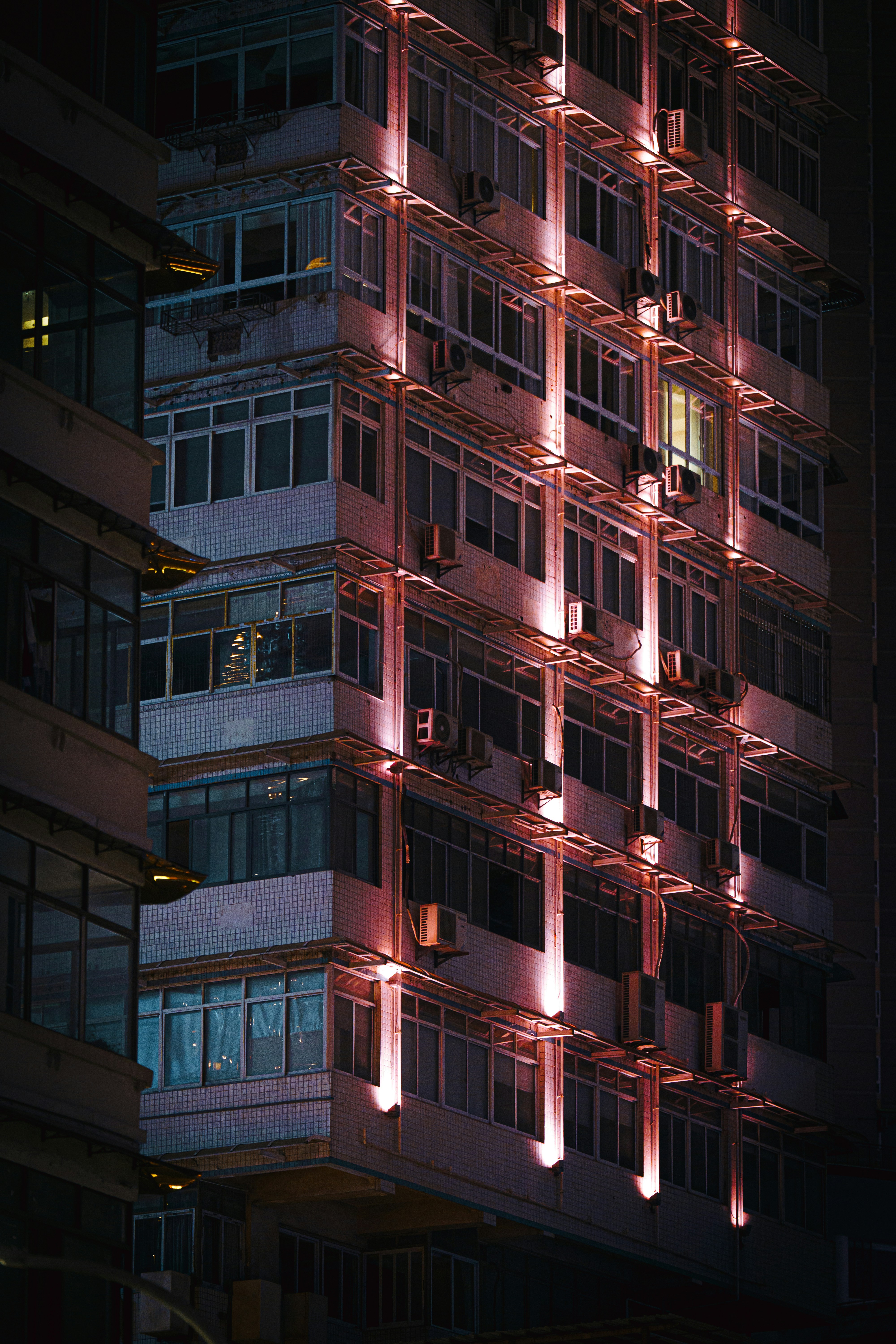 Neon Grid: Nighttime Facade Illuminations on a Moonlit Apartment Block