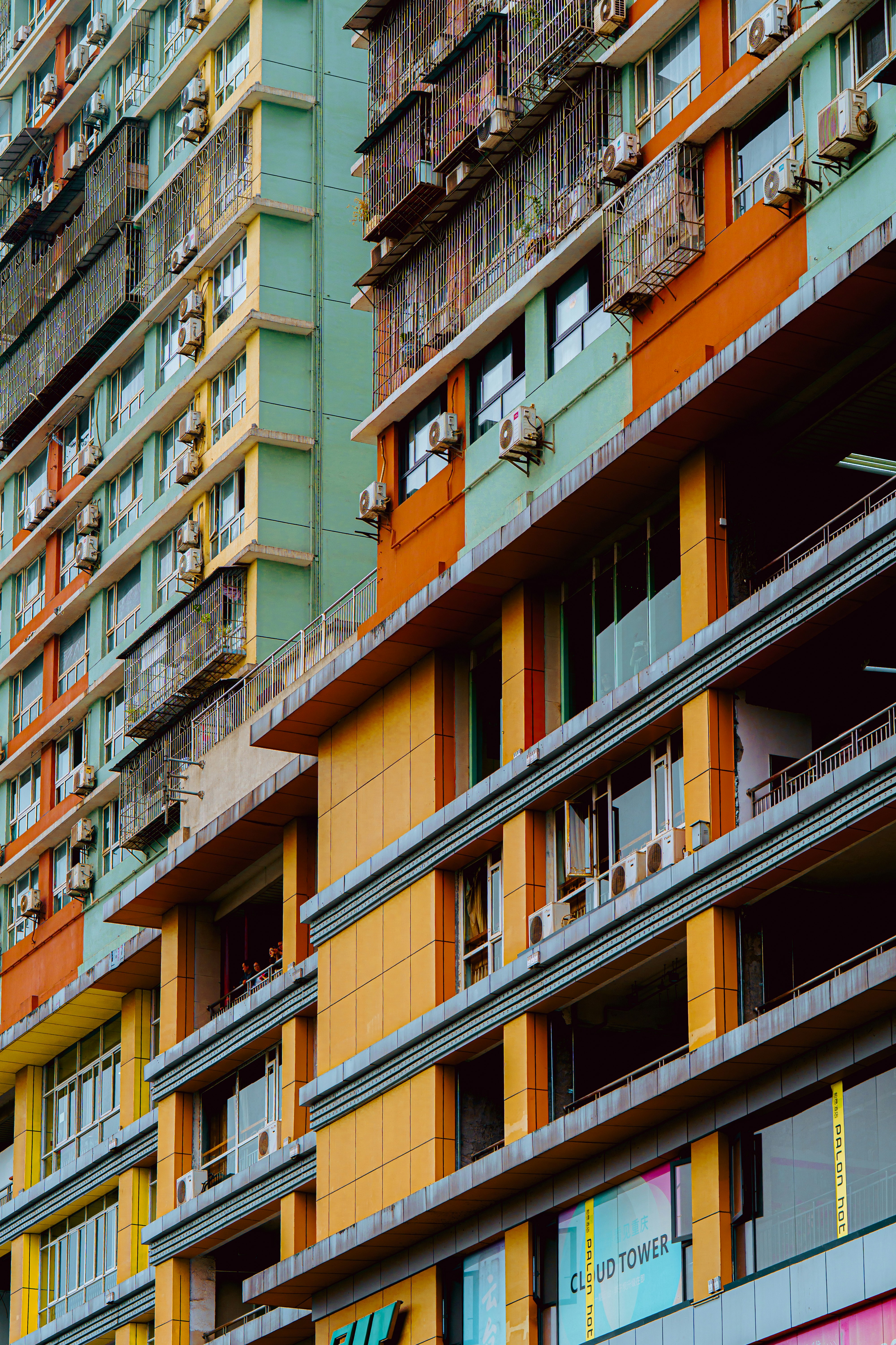 Color Blocks in Vertical City: A Facade of Orange, Mint, and Sky