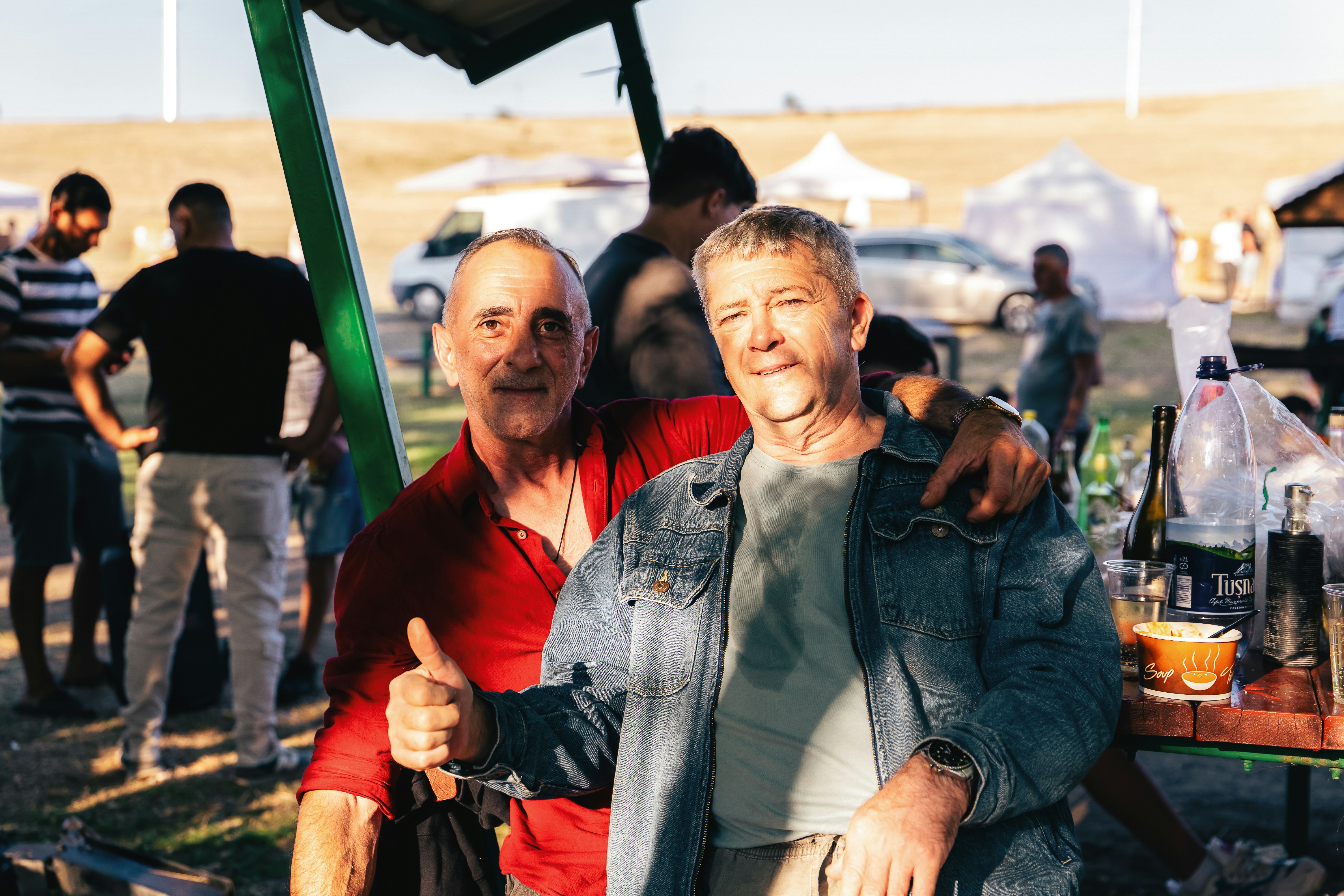 Two Friends at a Sunlit Outdoor Gathering