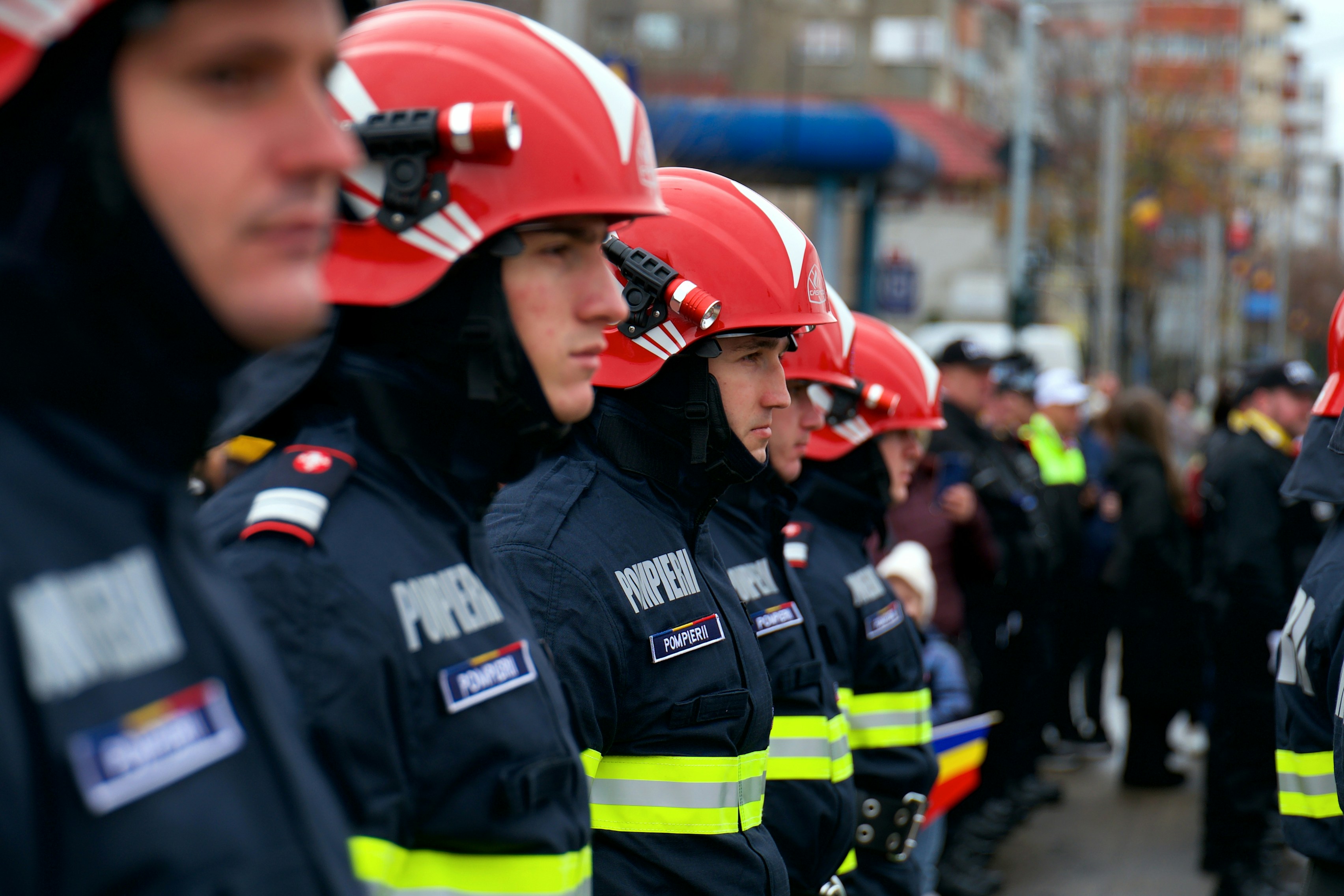 Line of Firefighters: Red Helmets and Neon Stripes