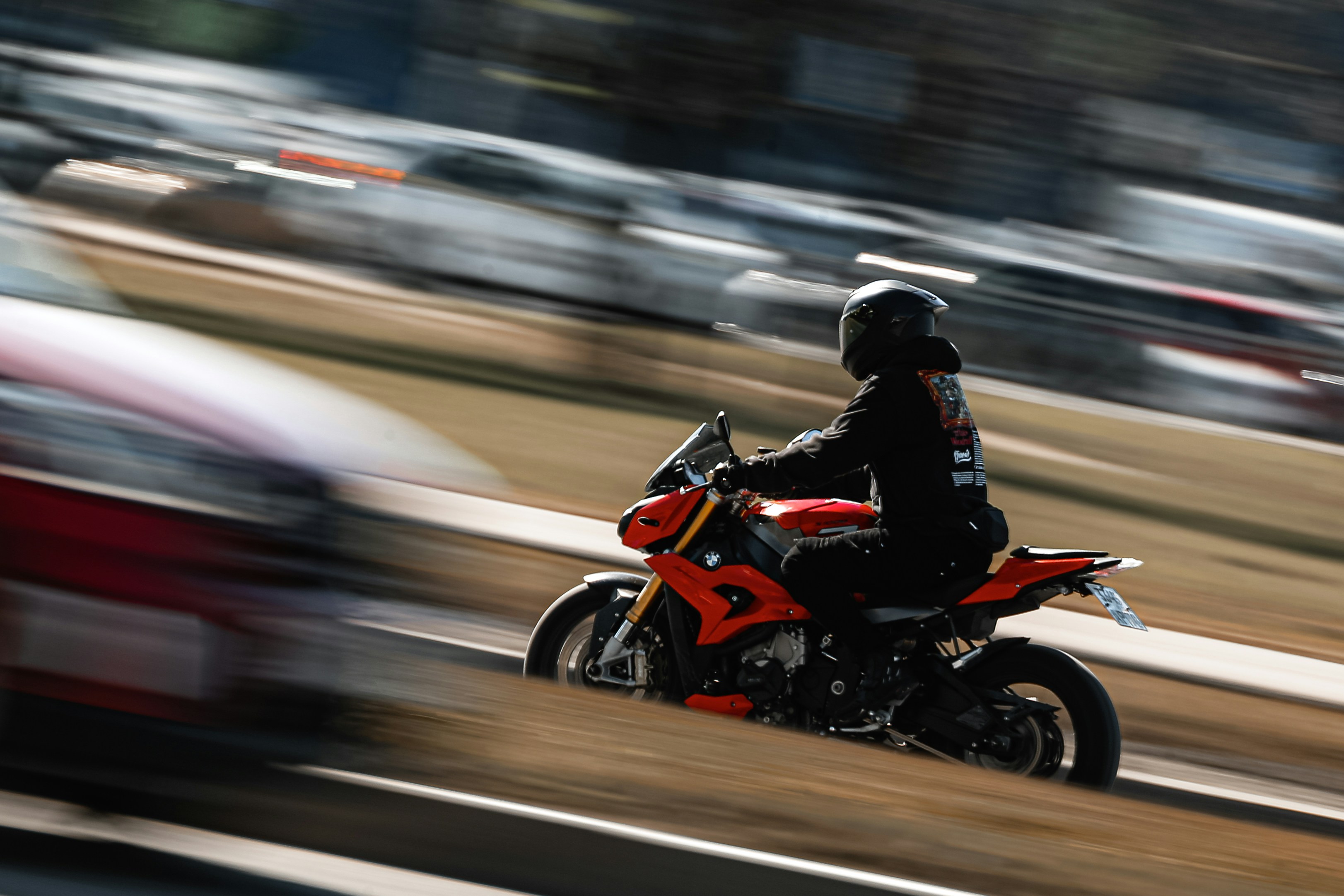 Red Rider in Motion: A Moto Cross Blur Across the Rails