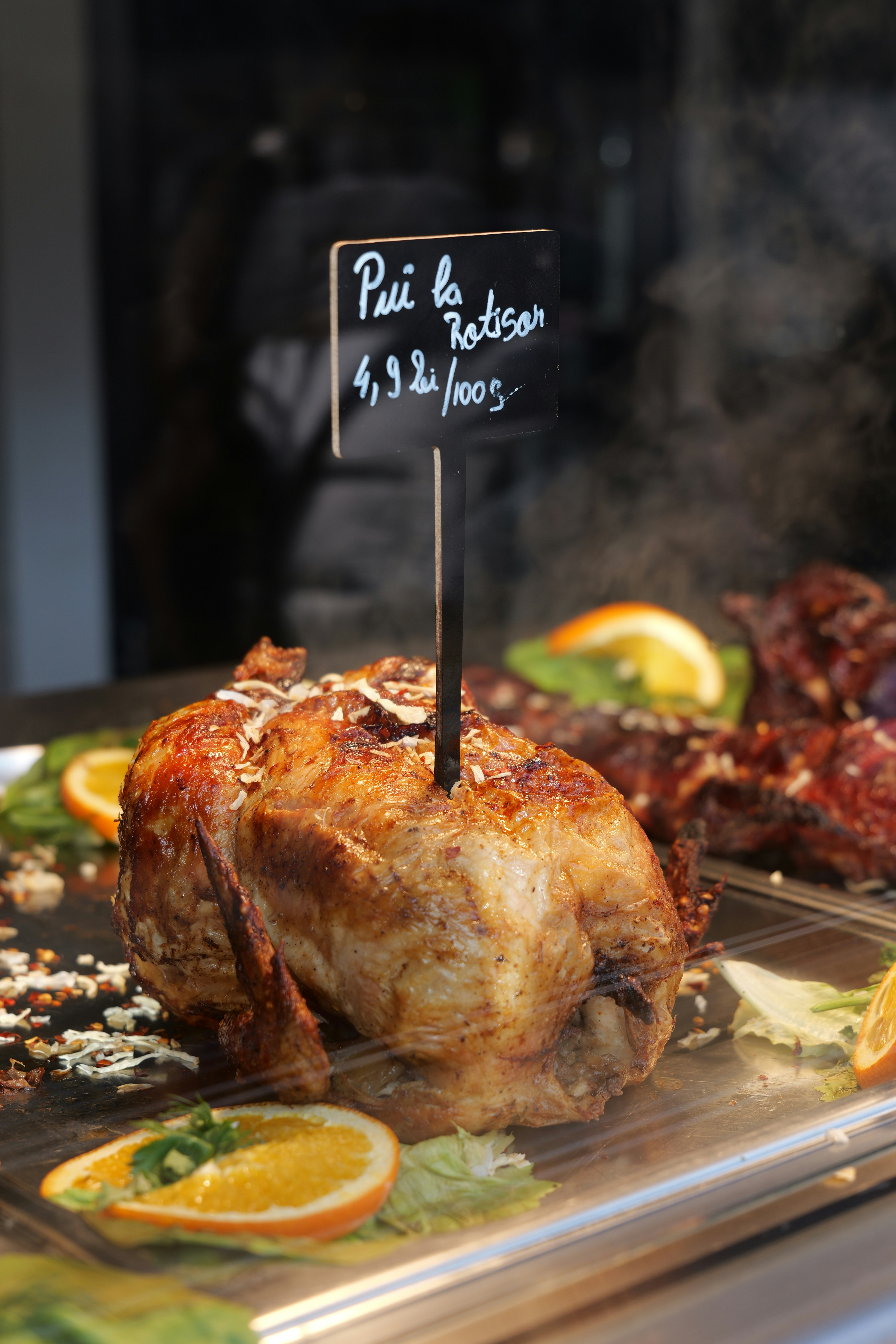 Roast at Center Stage: A Glazed Poultry Display with Handwritten Signage