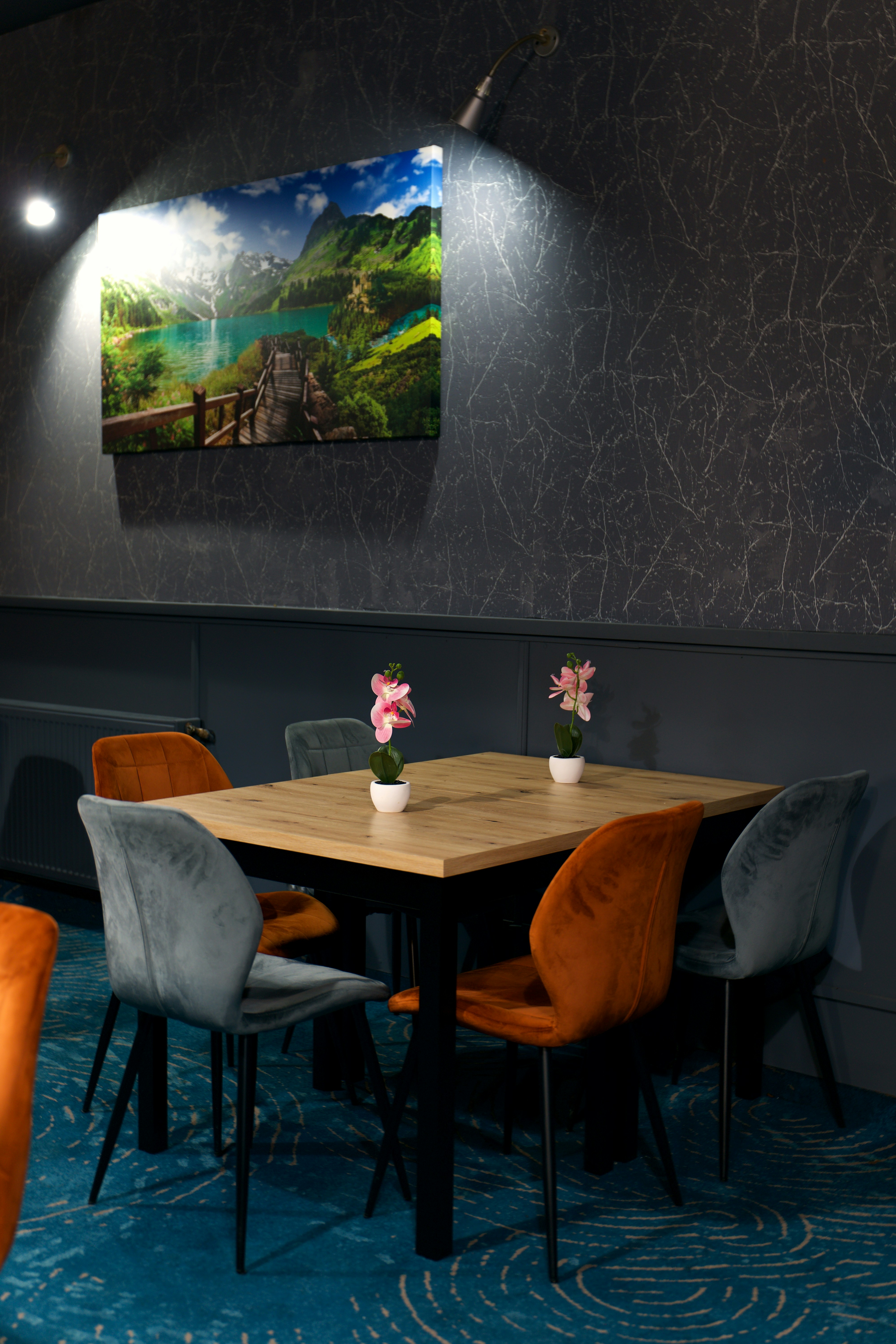 Sunlit Landscape on the Wall: A Cozy Café Table Beneath a Framed Drive