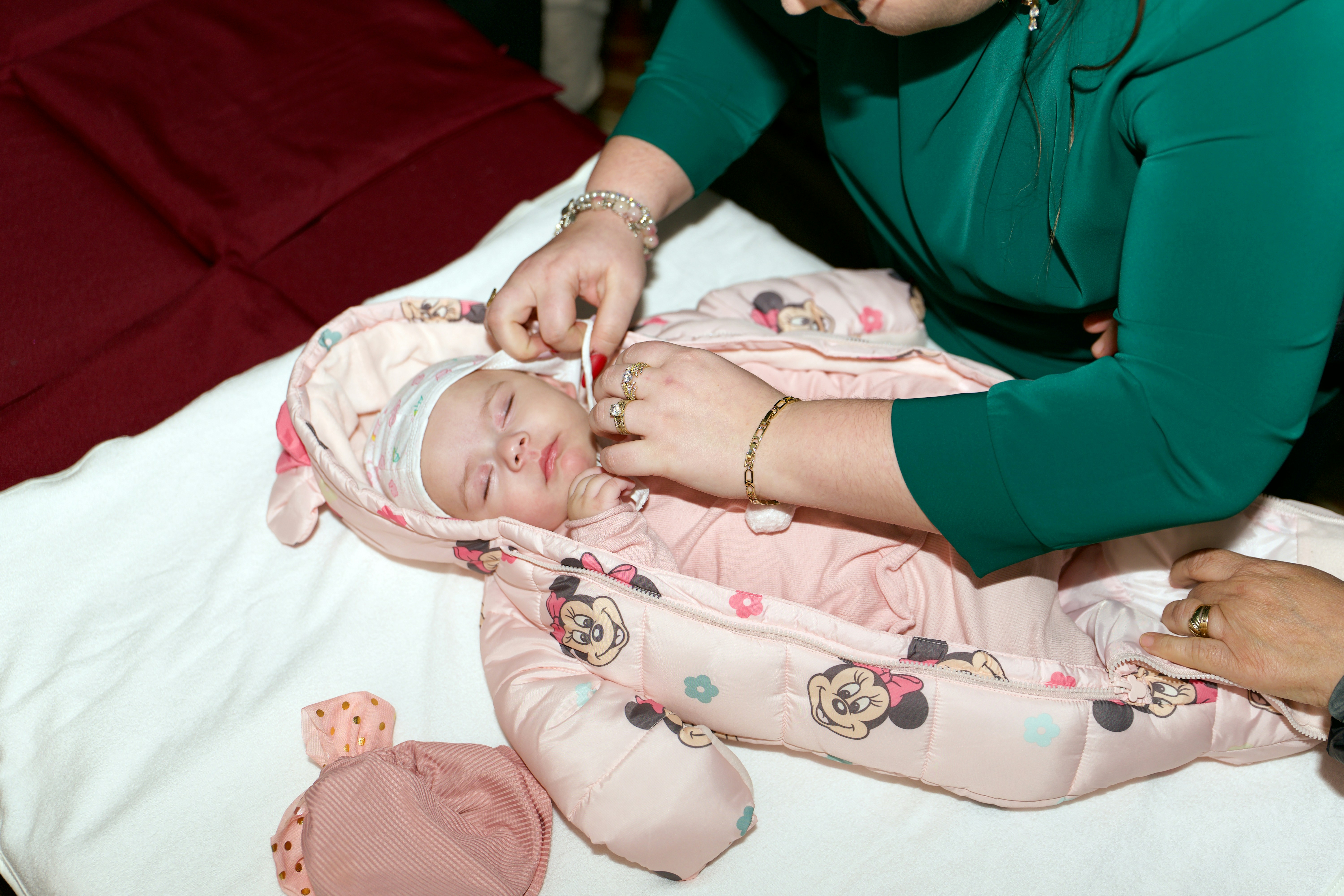 Tender Interlude: A Baby’s Quiet Slip into Sleep under Careful Hands