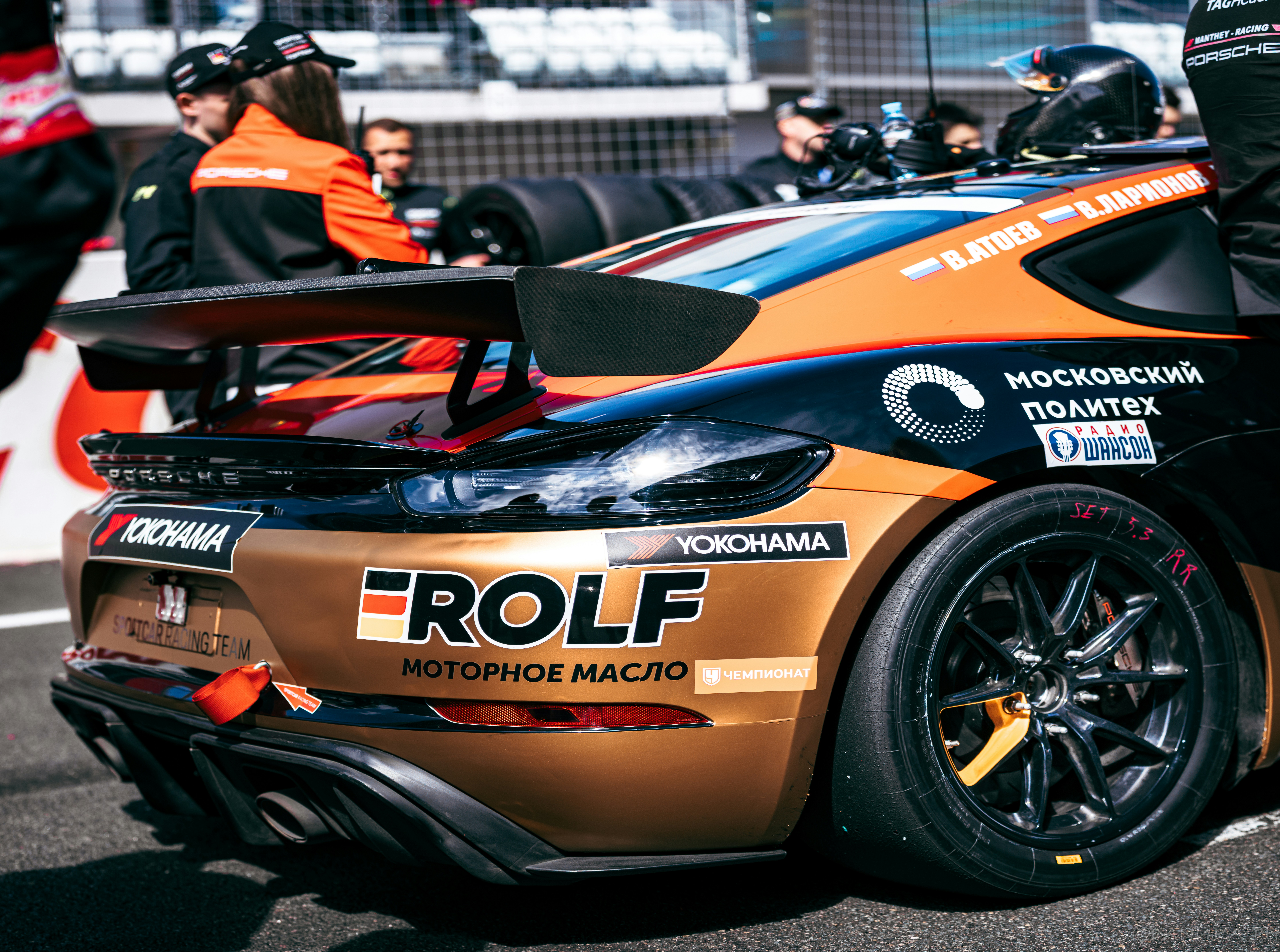 Race-ready Bronzed Beauty: Side View of a Spoiled, Sponsored GT Car