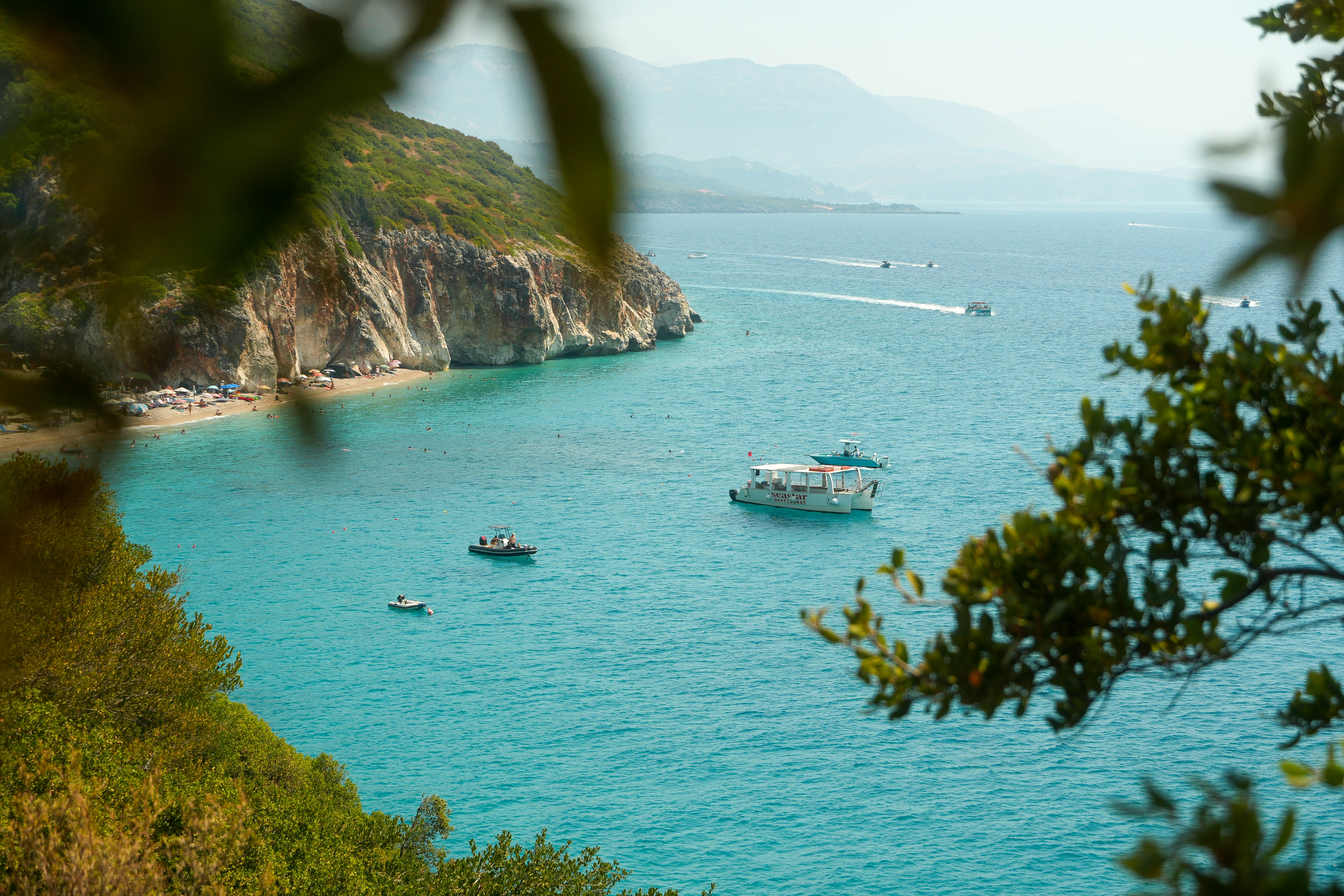 Azure Cove: Boats Tracing a Quiet Arc in Coastal Blue