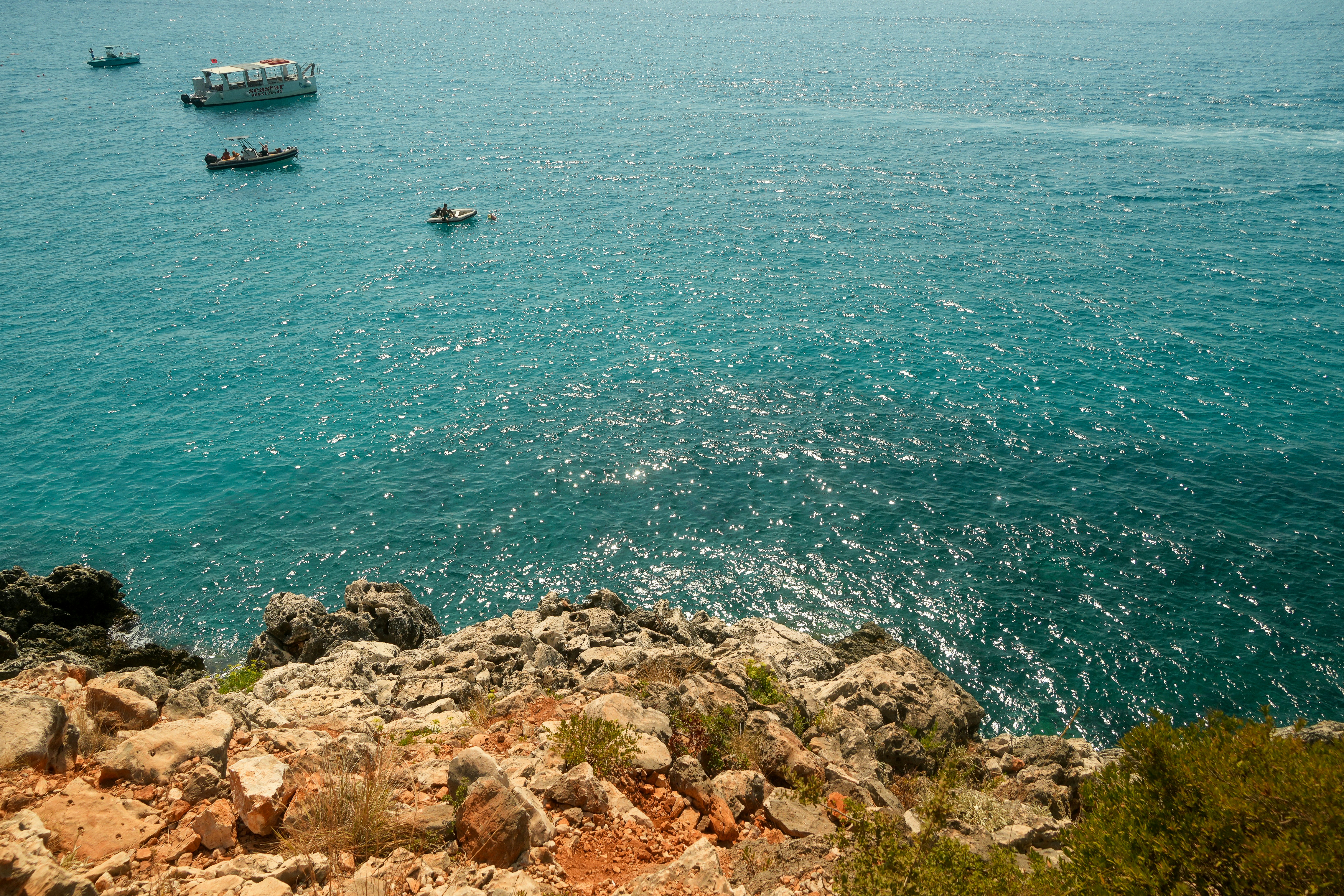 Azure Edge: Sunlit Rocks Meet the Sea