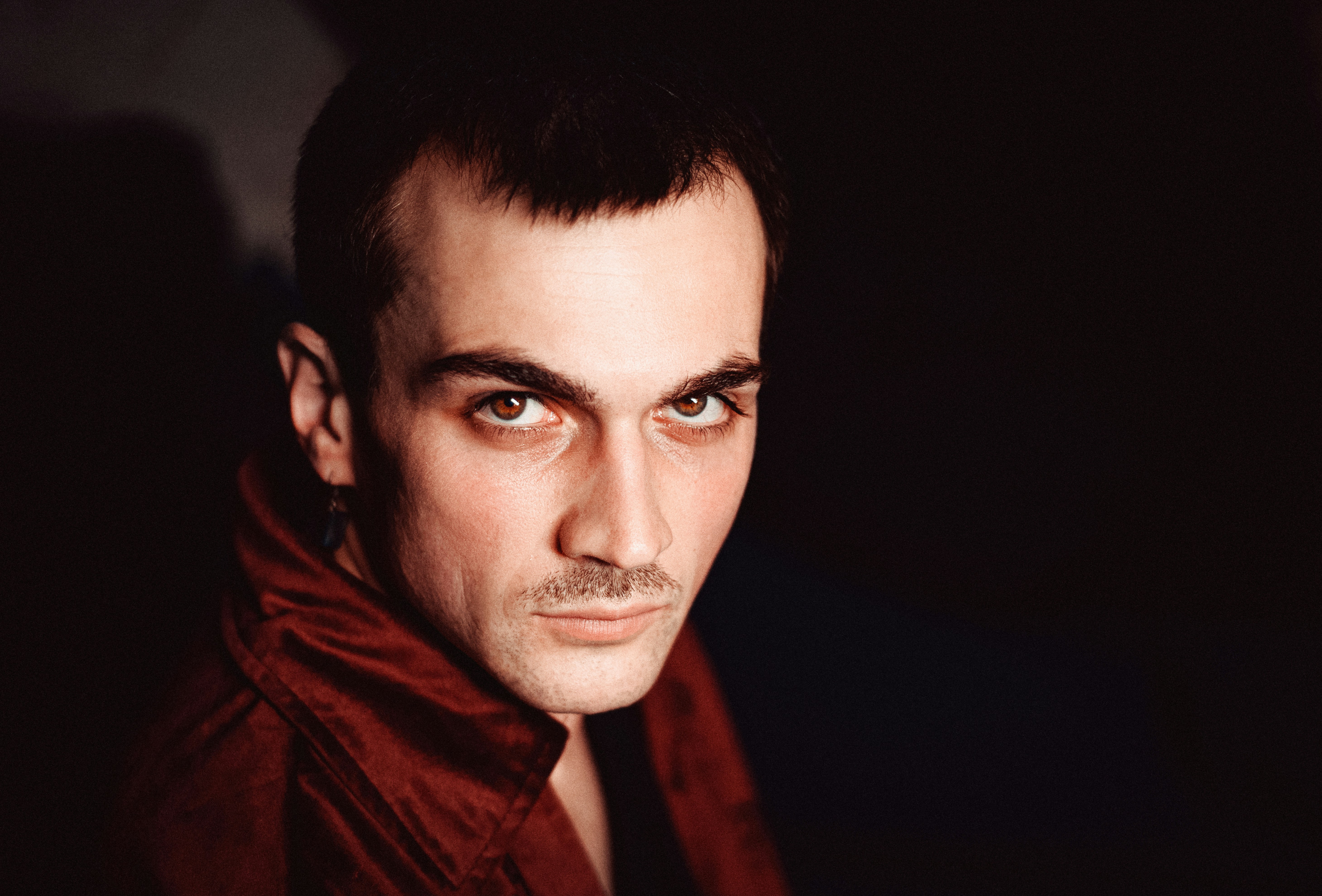 Amber-lit Gaze: A Portrait with Quiet Intensity