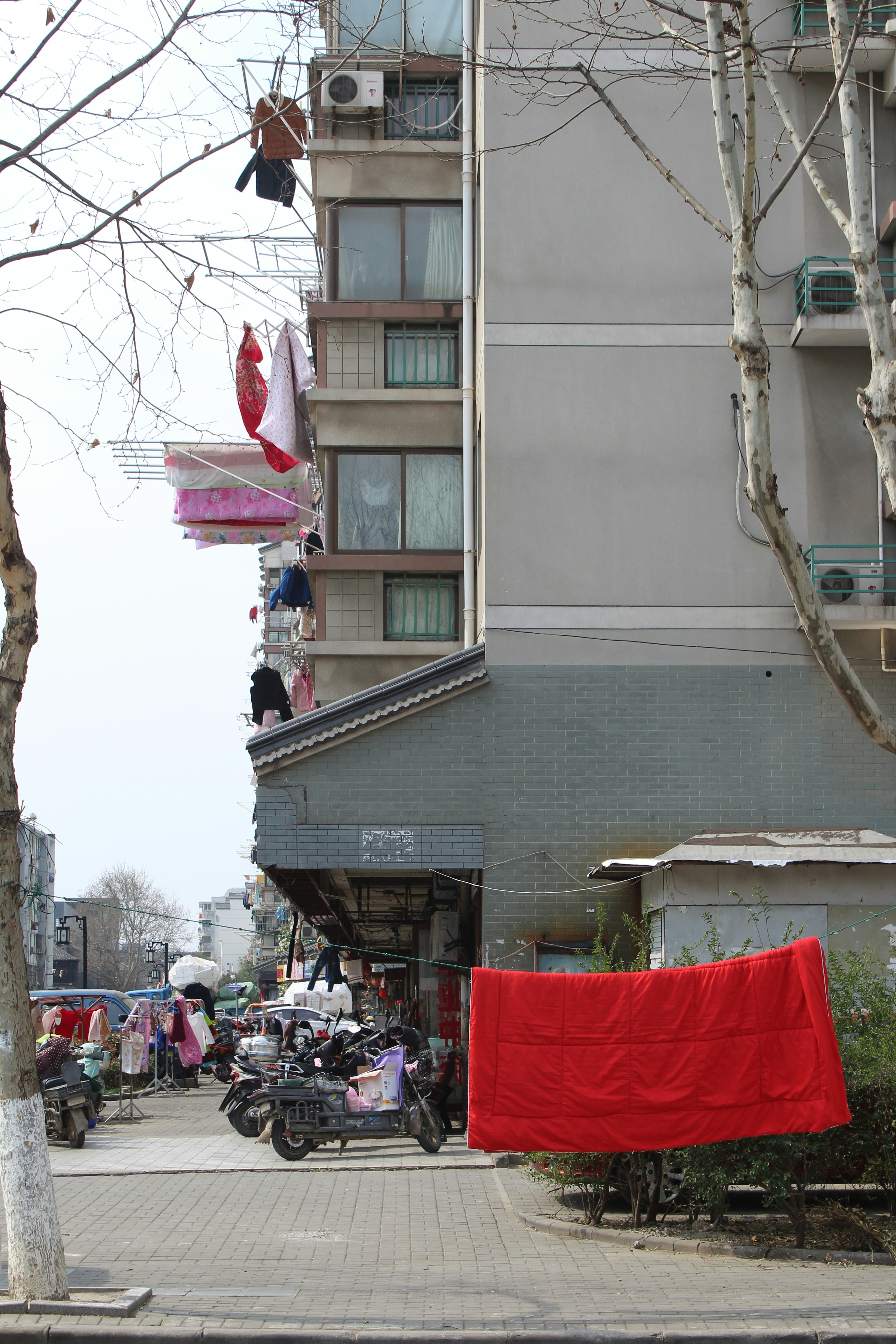 Red Laundry Banner over a Quiet Urban Street