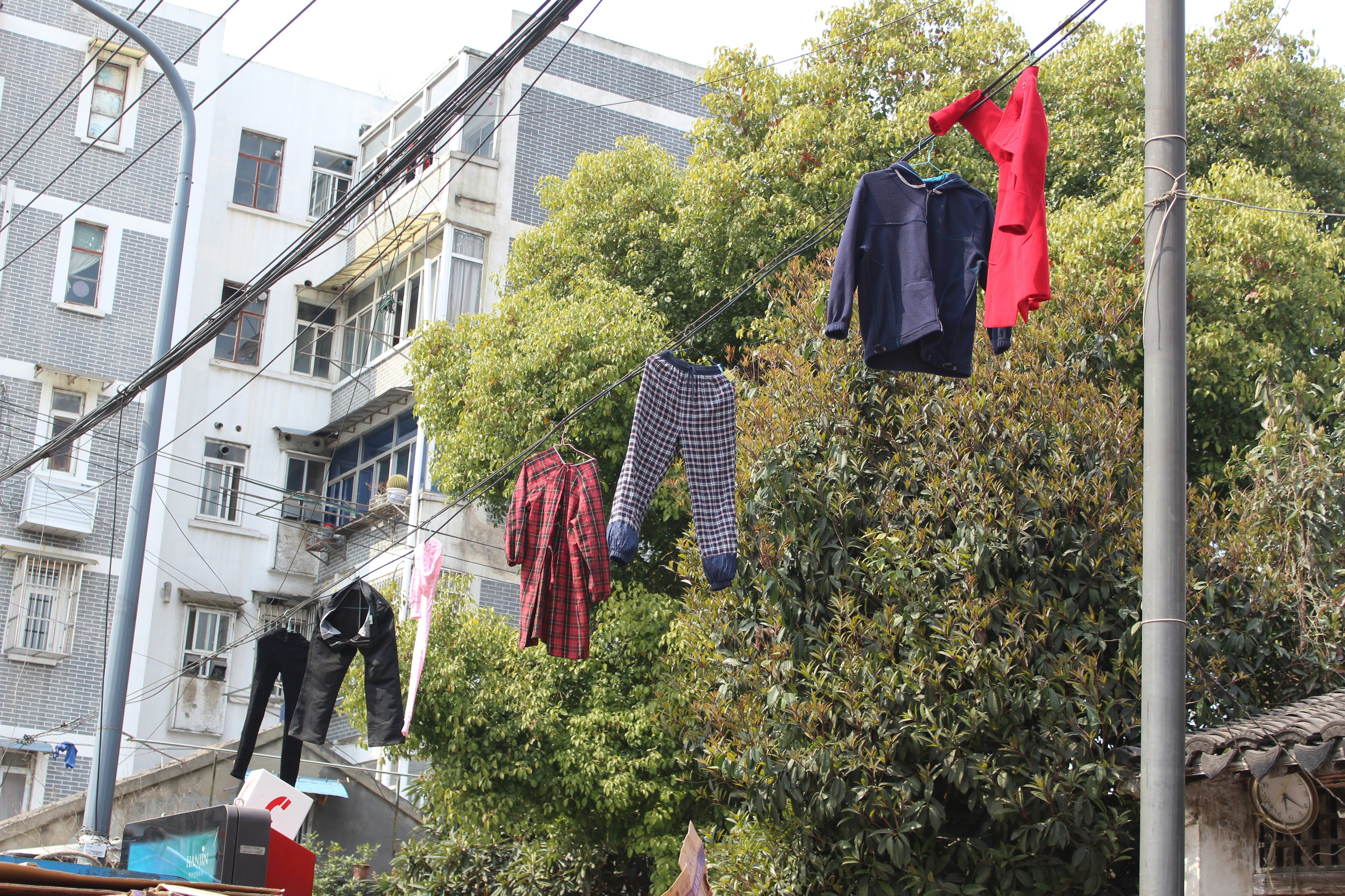 Clothesline Arc: Laundry Swinging Between Buildings